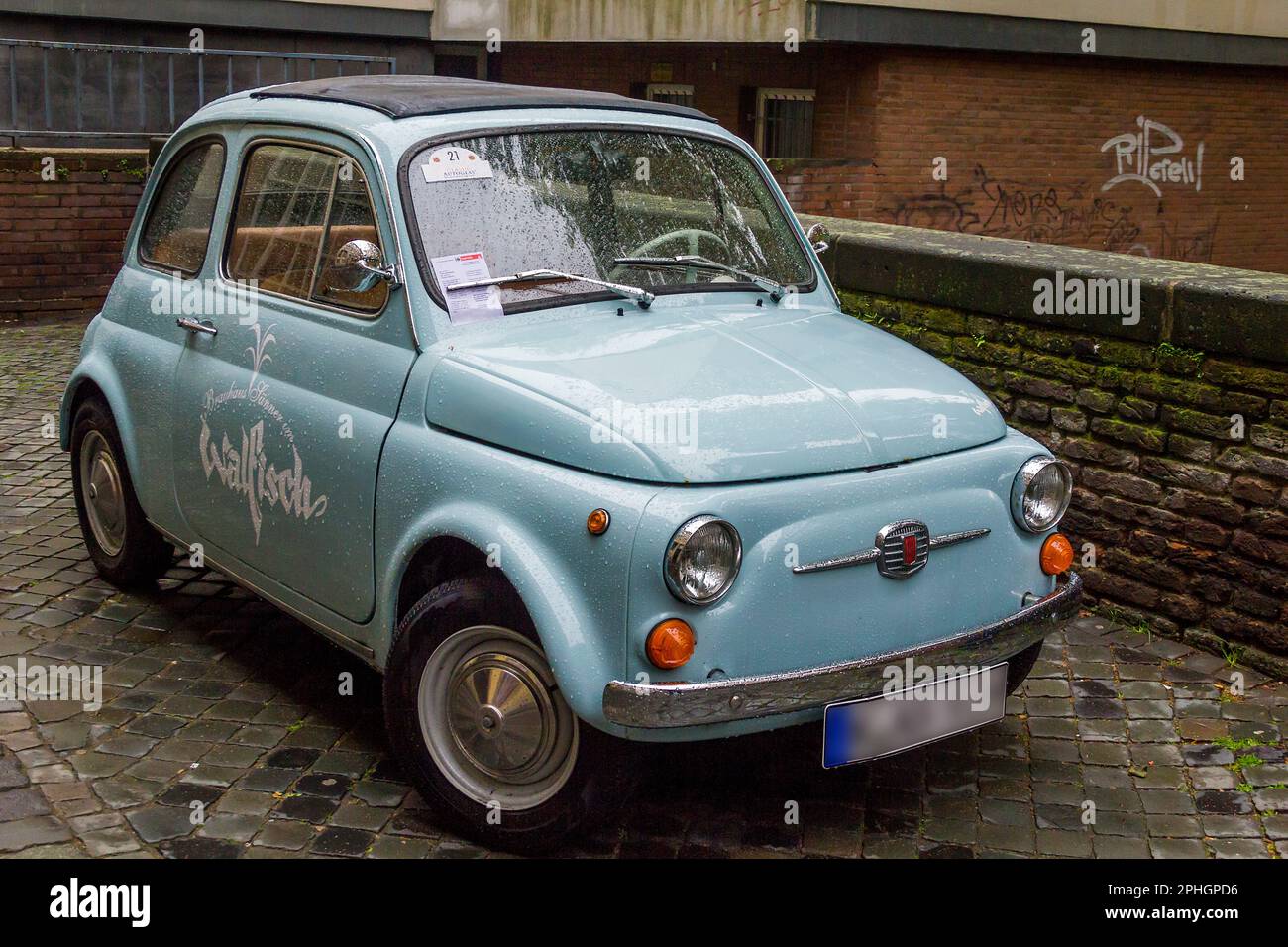 This is the old mass production car Fiat Nouva 500 on cobbled parking ...