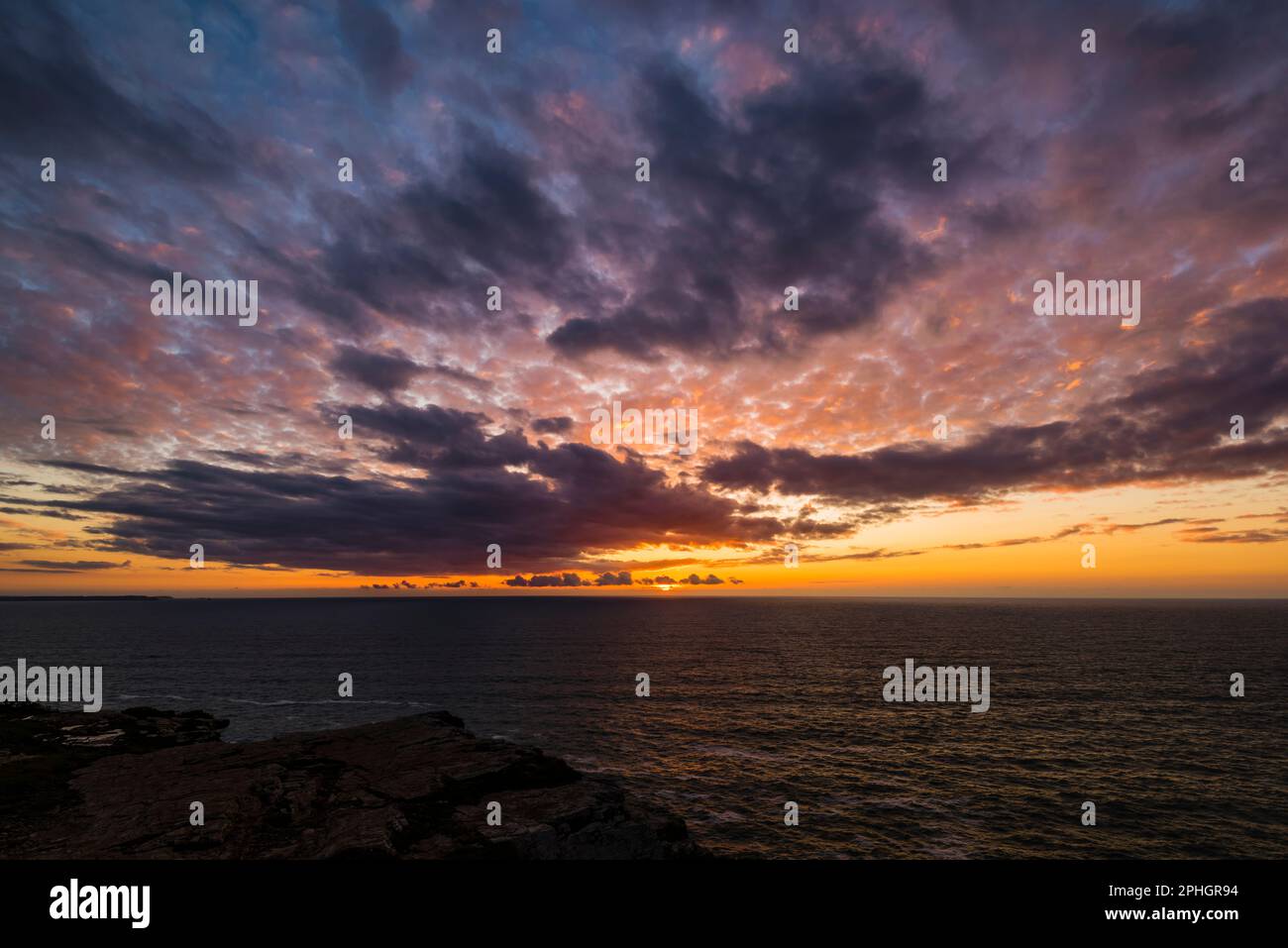 Orange colours in the sky and clouds at sunset, from Glebe Cliff ...