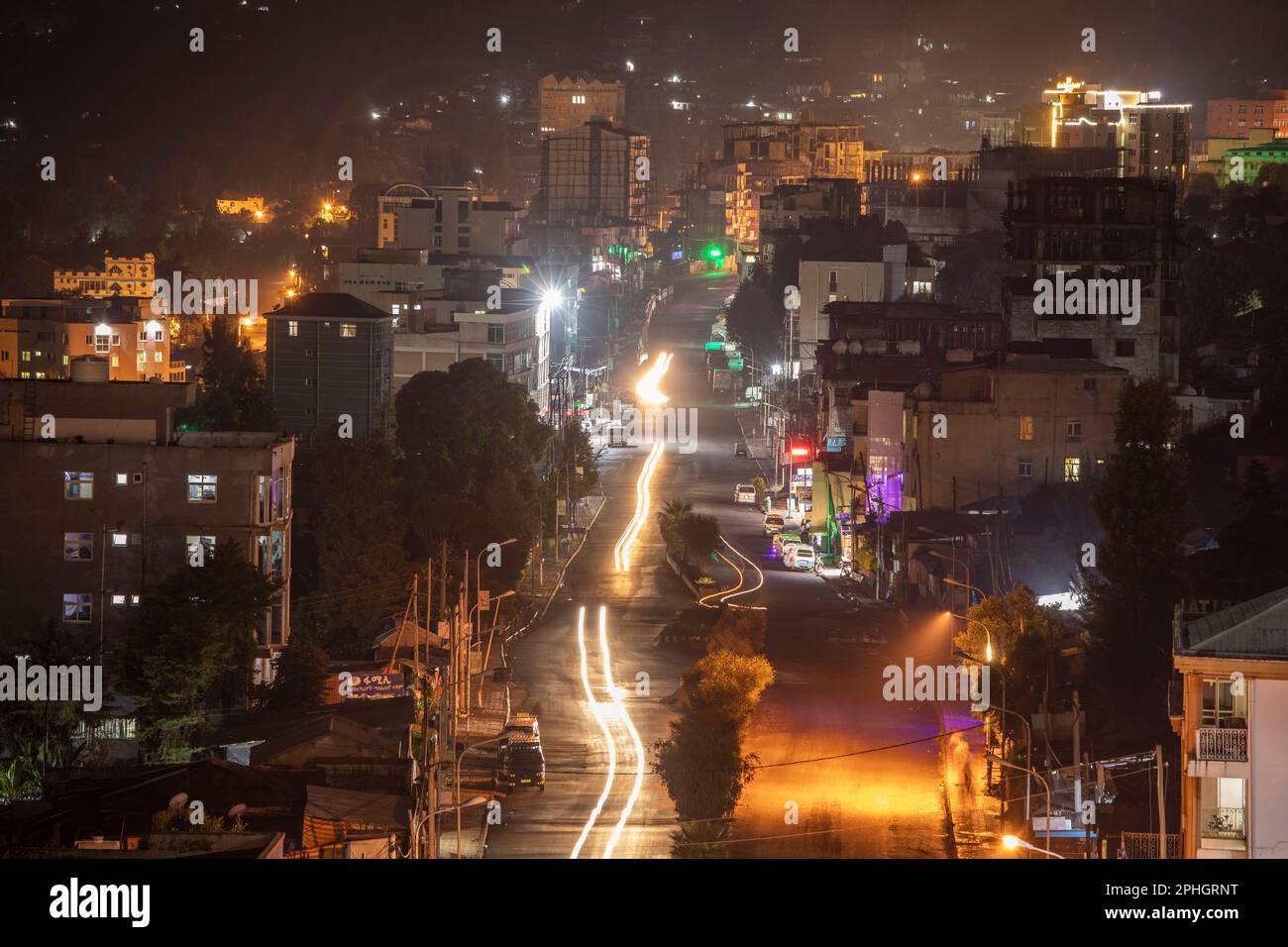 Low aerial night view of the city of Dessie, Ethiopia with traffic and ...
