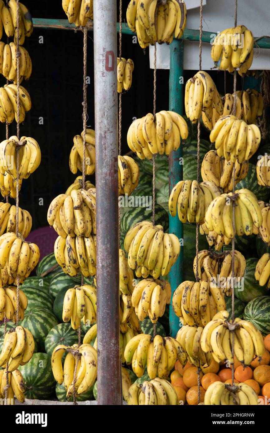 Bananas hang from a display at an outdoor market in Dessie, Ethiopia ...