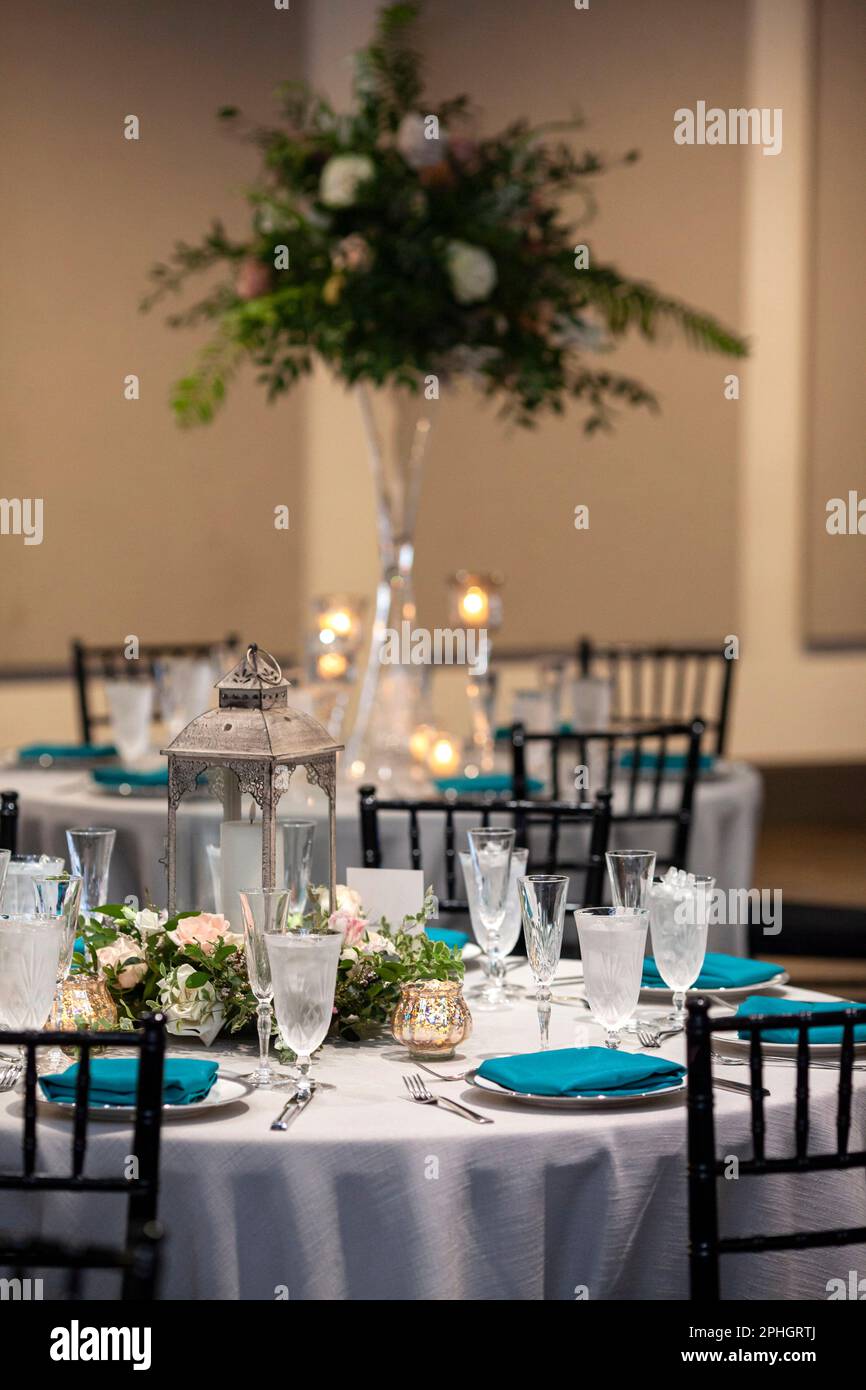 Tables set up for a formal wedding reception with nice glassware and ...