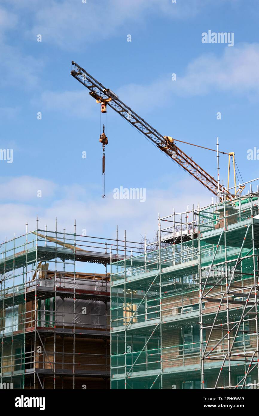 crane scaffolding and safety nets on construction site building new ...