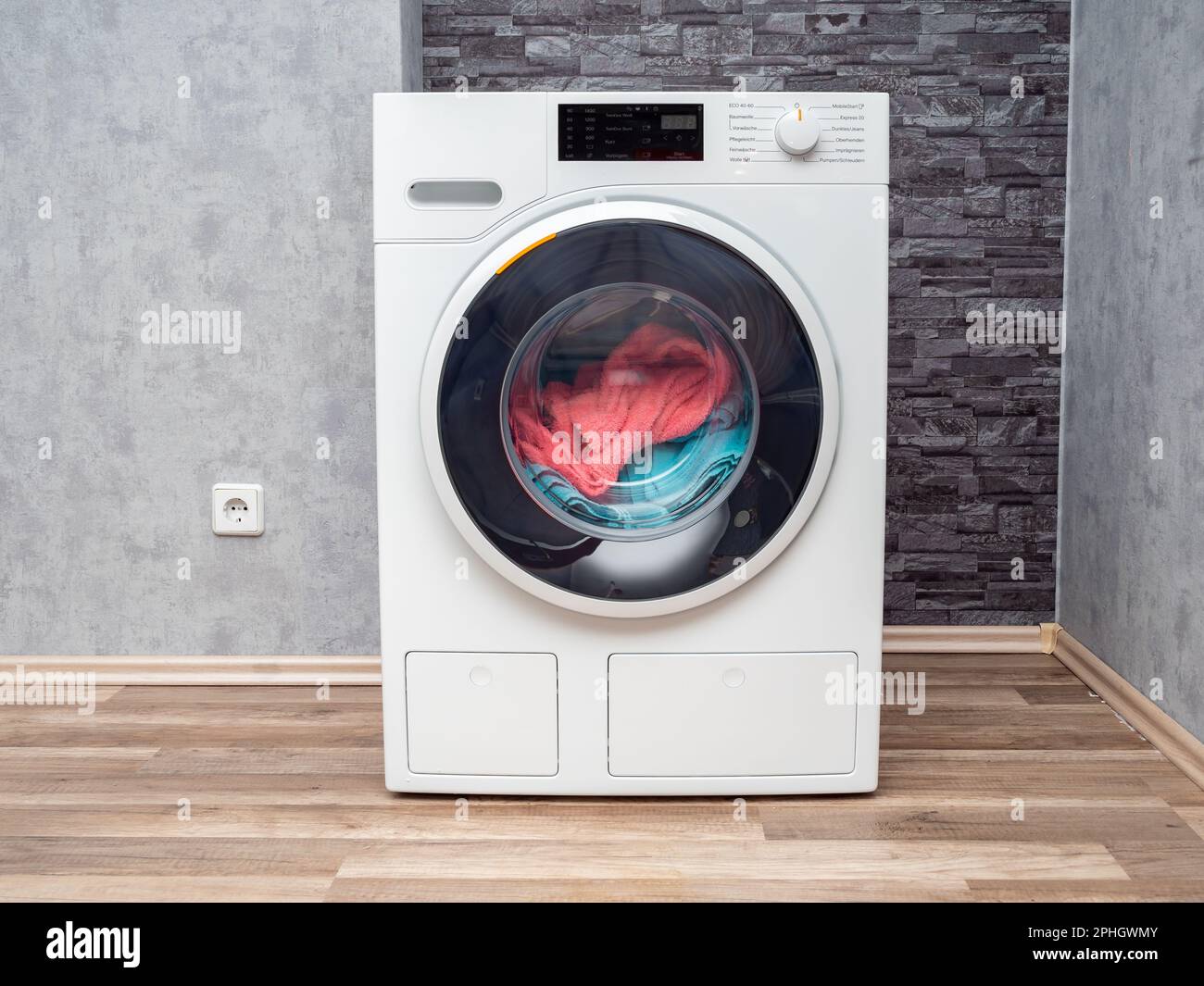 Laundry room interior with washing machine against the wall. Modern ...