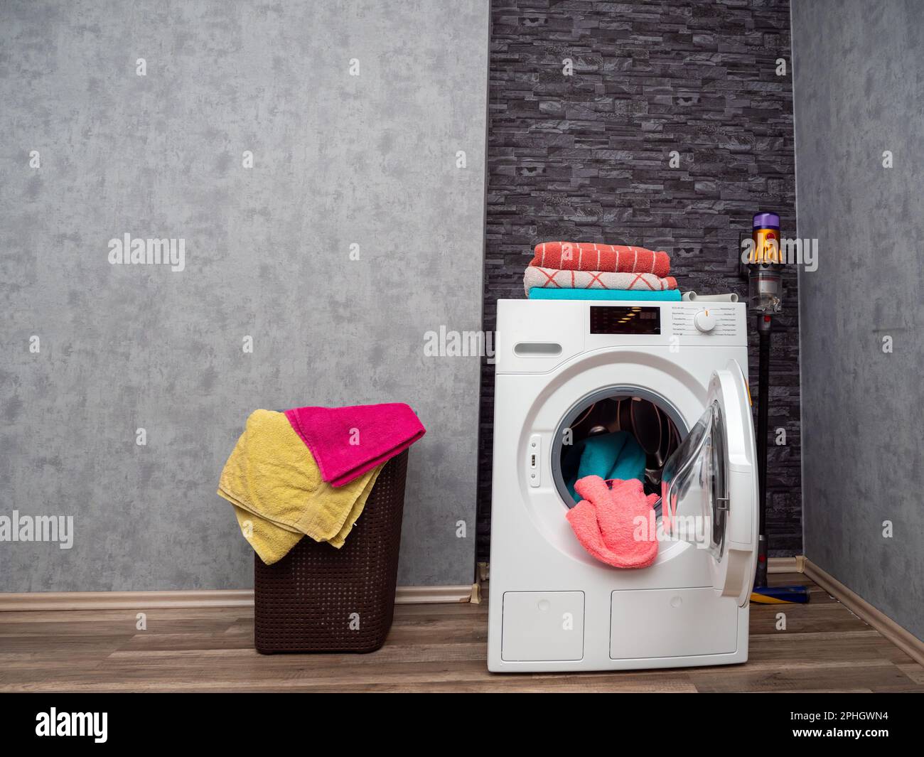 Laundry room interior with washing machine against the wall. Modern ...