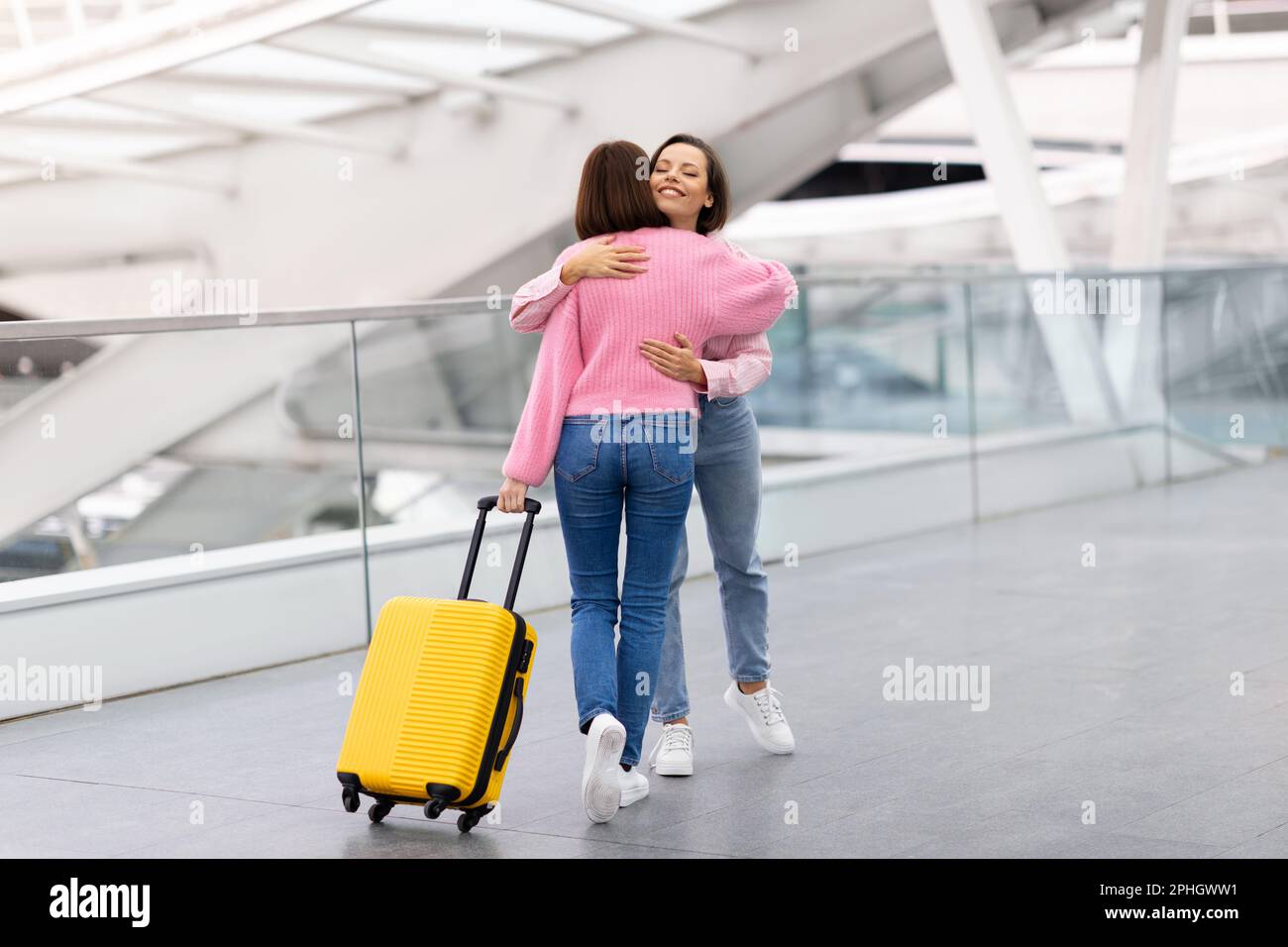 Meeting At Airport. Two Female Friends Embracing At Terminal Hall After ...