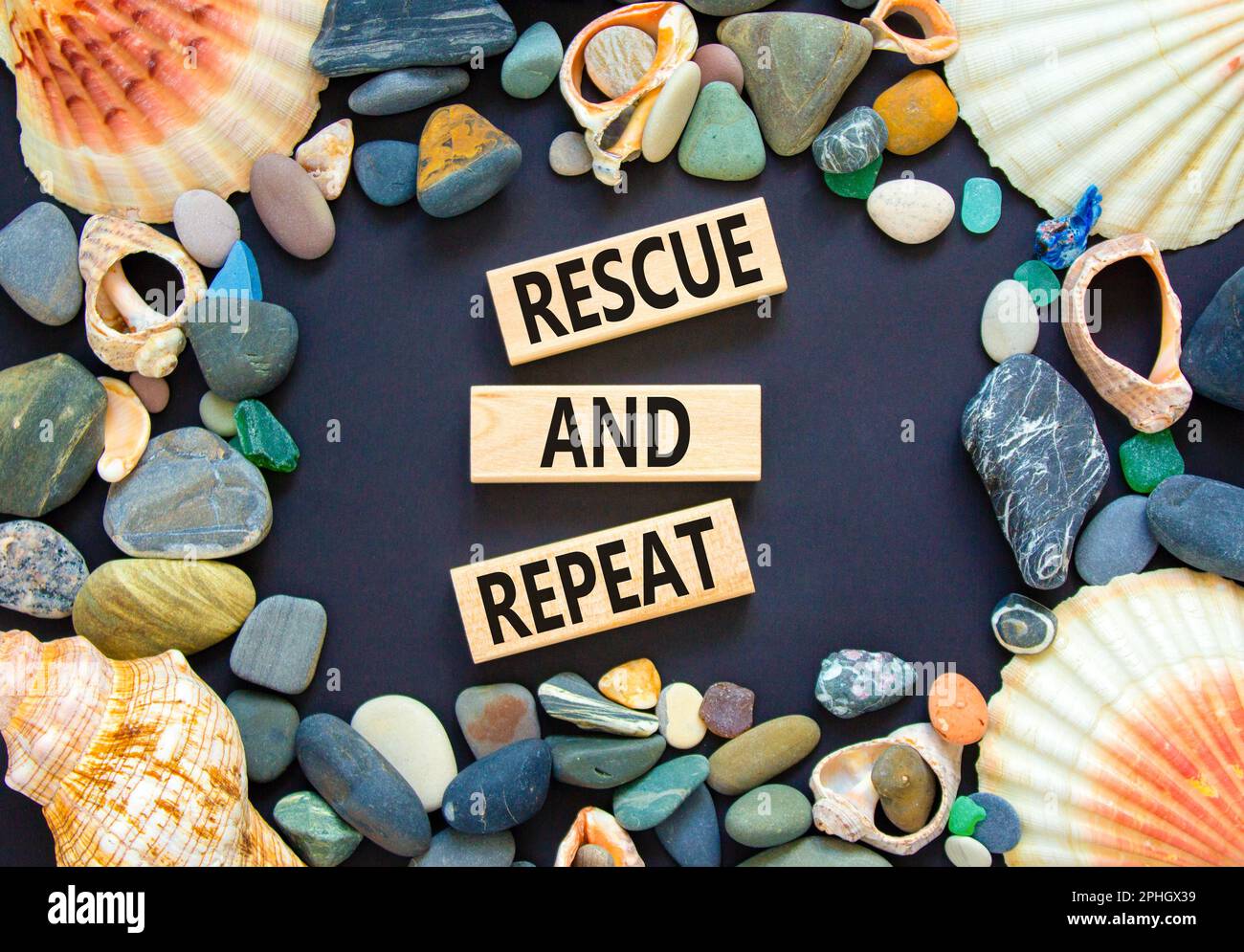 Rescue and repeat symbol. Concept words Rescue and repeat on wooden block on a beautiful black ...
