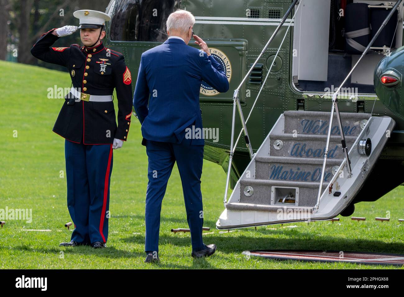 United States President Joe Biden salutes the US Marine Guard as he ...