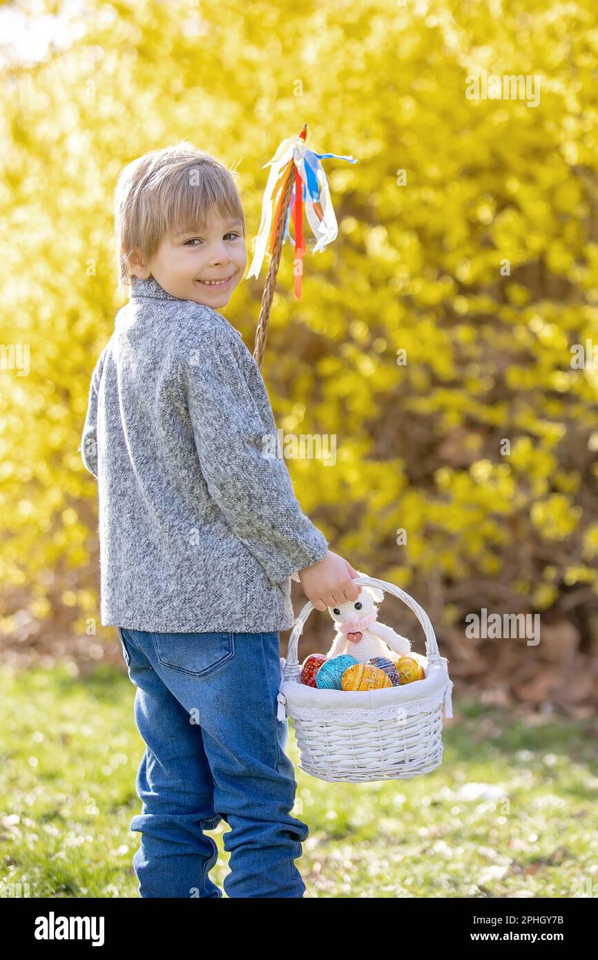 Cute preschool child, boy, holding handmade braided whip made from ...