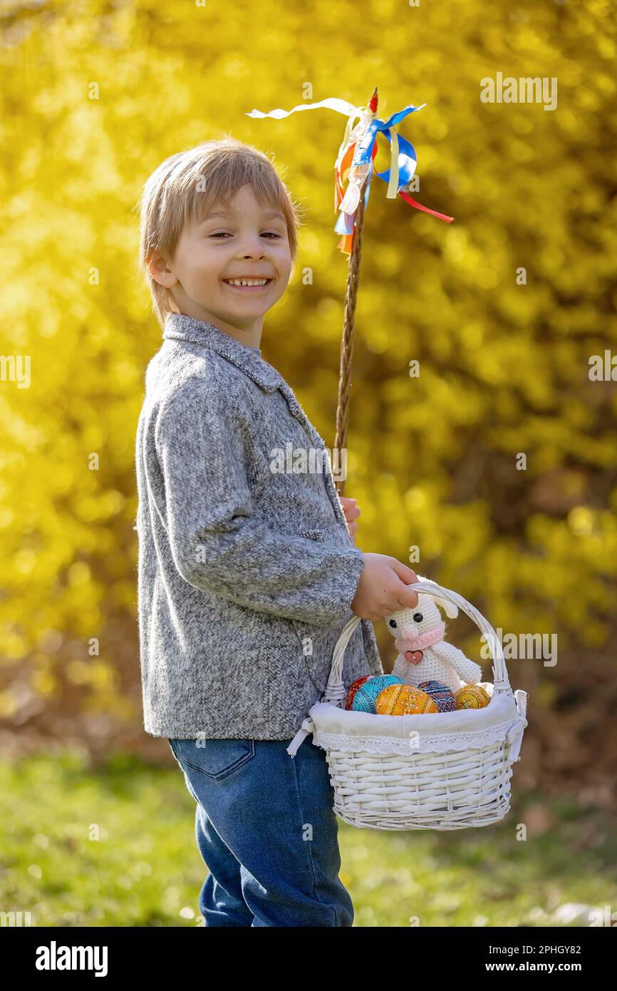 Cute preschool child, boy, holding handmade braided whip made from ...