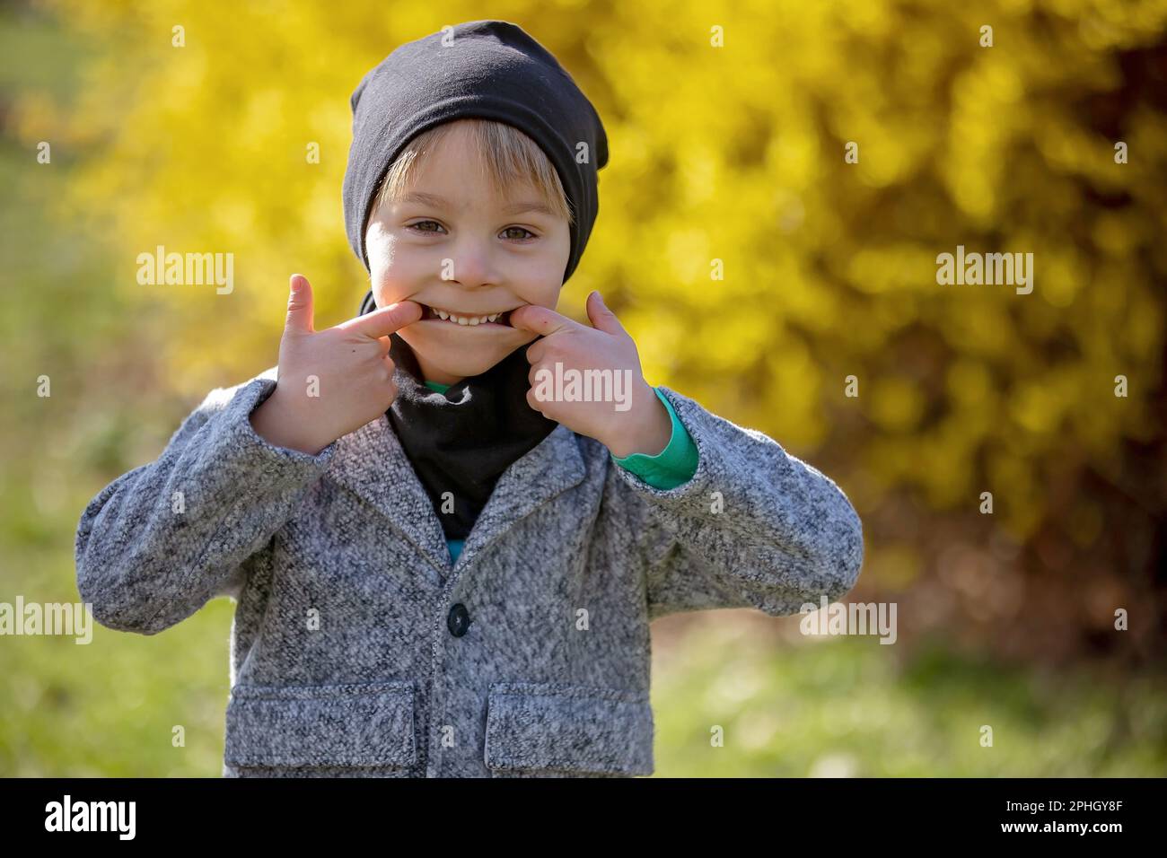Cute preschool child, boy, holding handmade braided whip made from ...