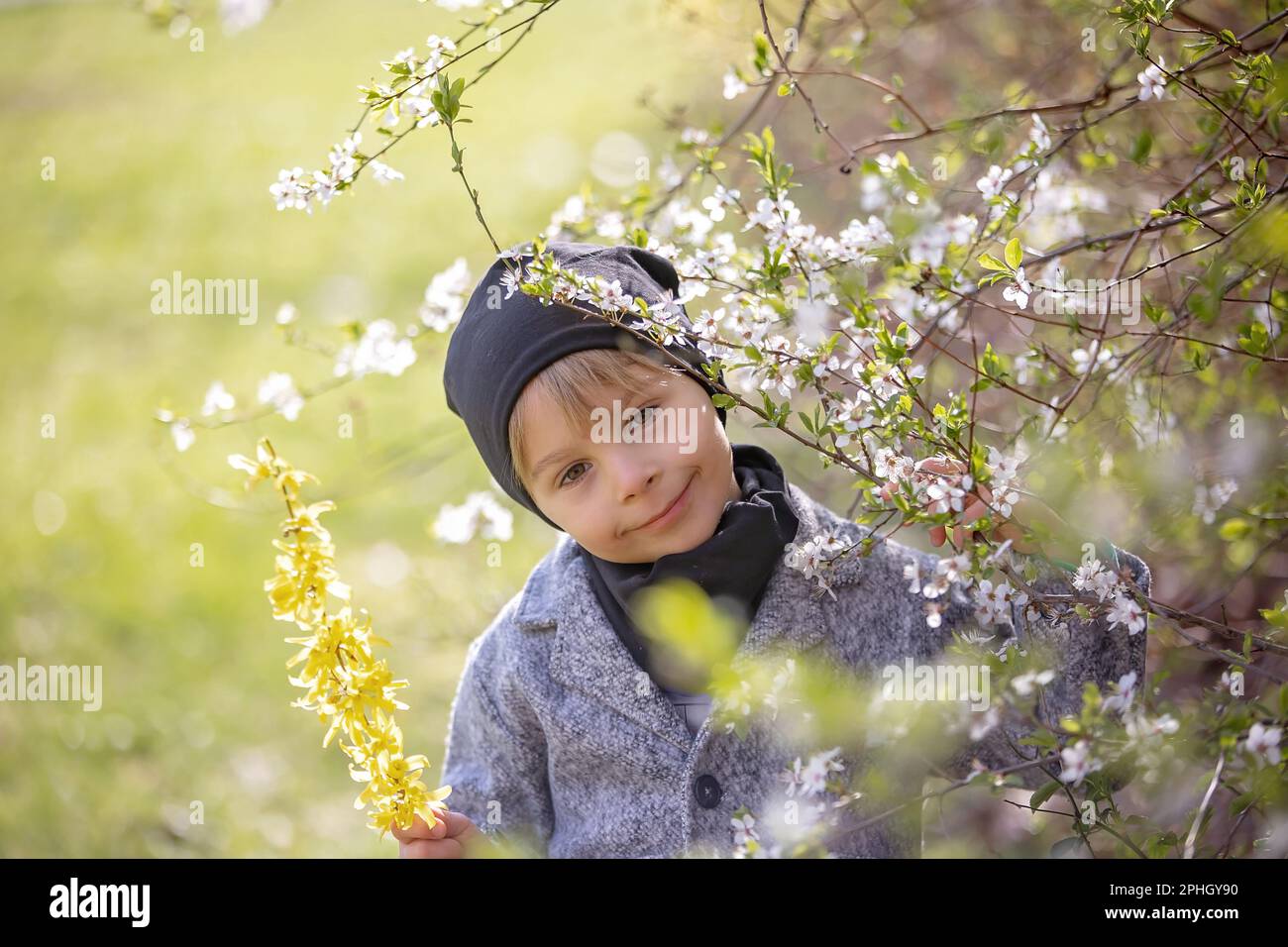 Cute preschool child, boy, holding handmade braided whip made from ...