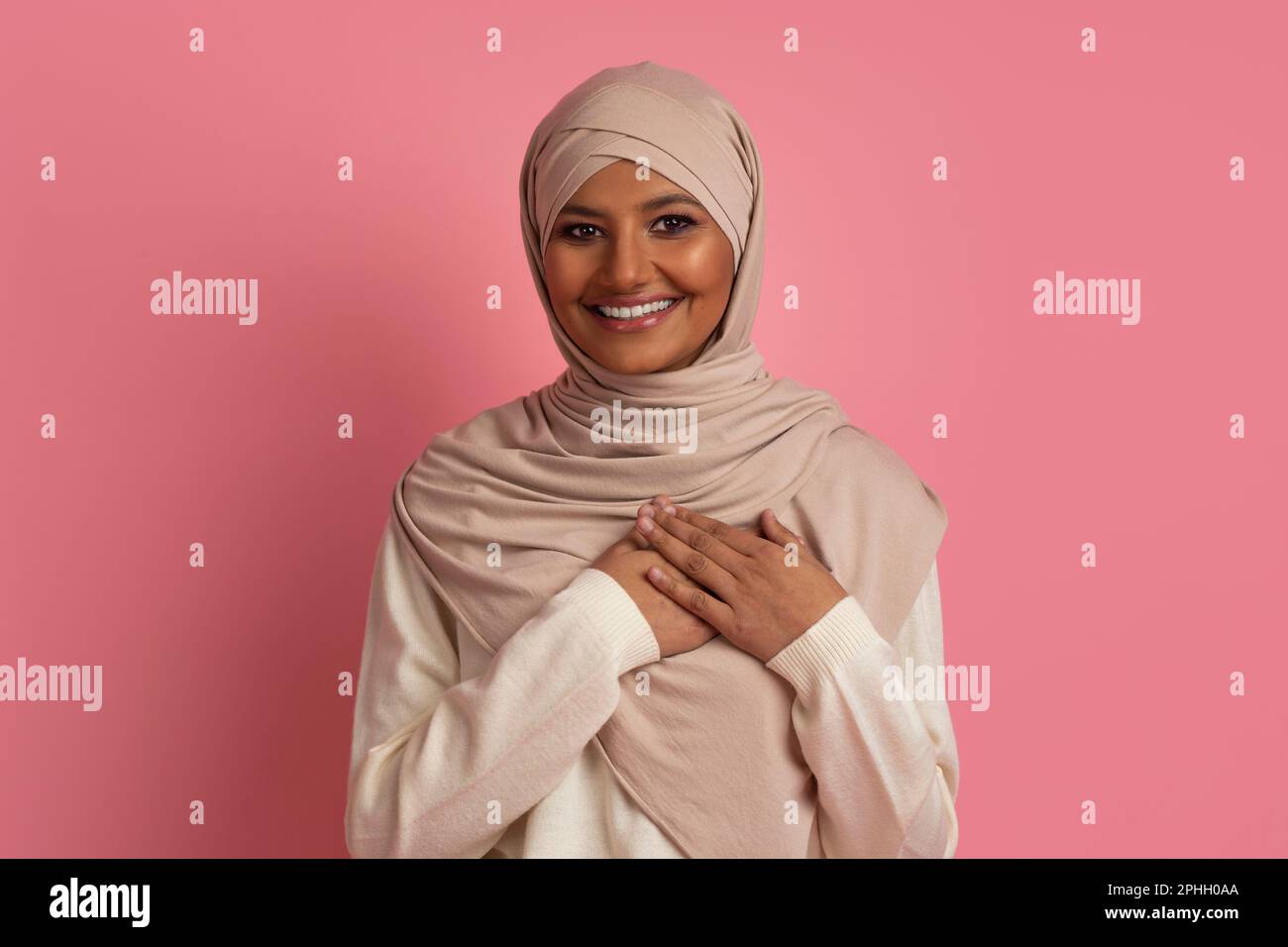 Gratitude Concept. Thankful muslim woman in hijab keeping hands on ...