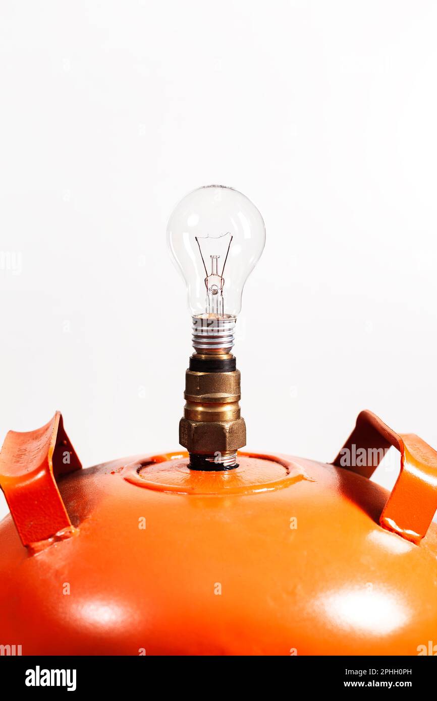 Close-up of an unlit light bulb placed in the valve of a orange ...