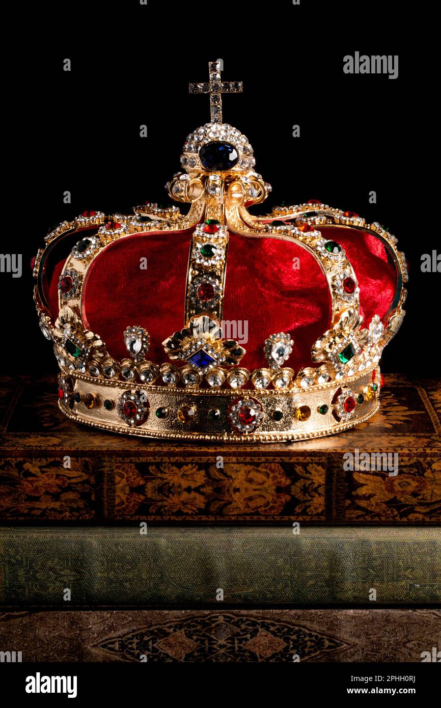 Gold Coronation Crown with Red Velevet on a Stack of Antique Books ...