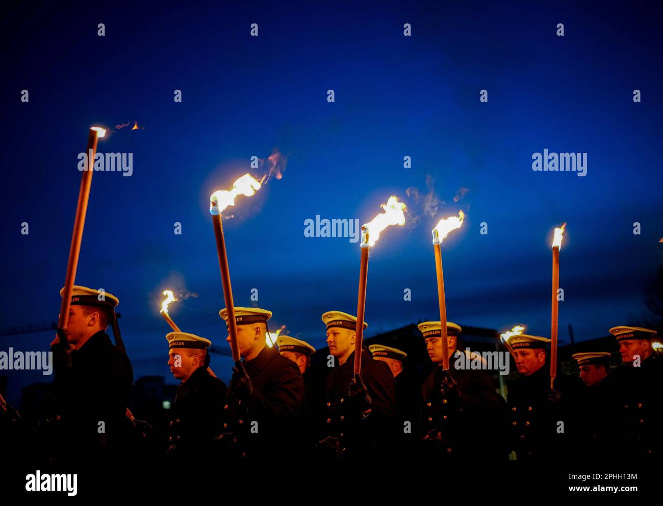 Berlin, Germany. 28th Mar, 2023. With torches, Bundeswehr soldiers of ...
