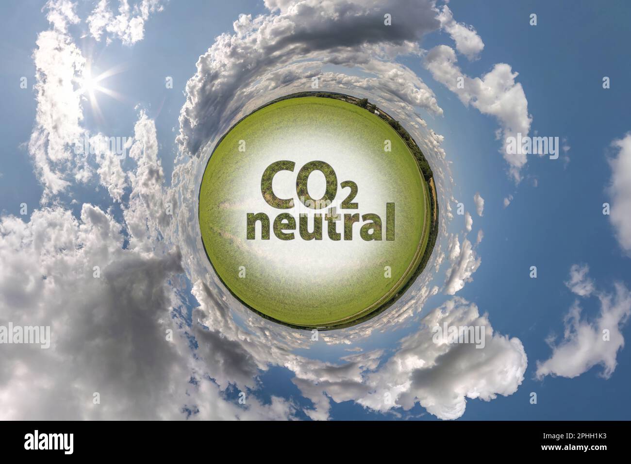 CO2 Neutral text concept image against green tiny planet in blue sky ...