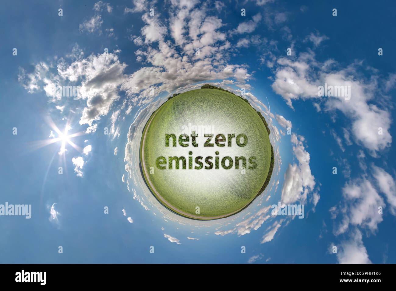 net zero emissions text concept image against green tiny planet in blue ...