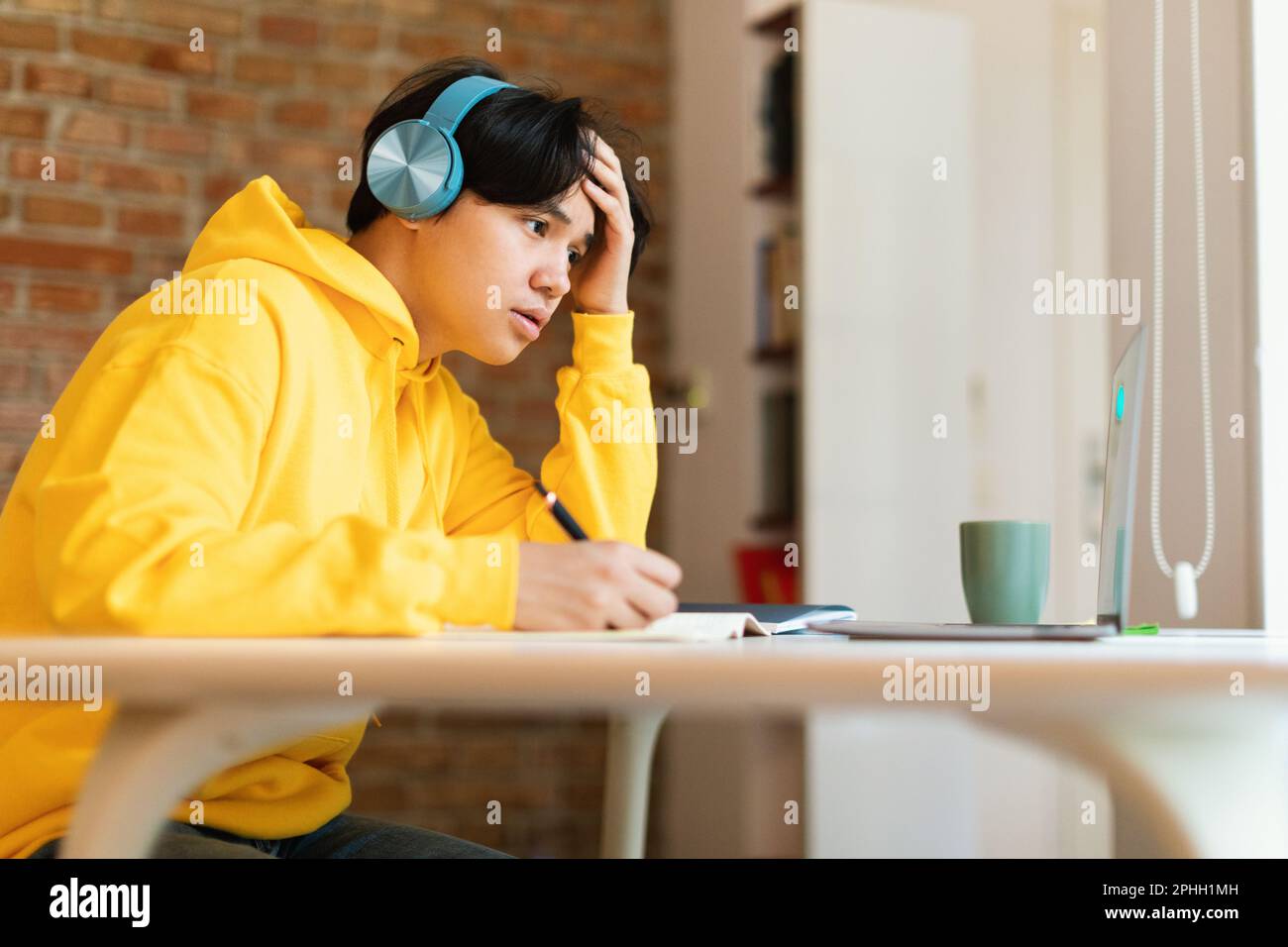 Korean Teenager Boy At Laptop Learning Online Wearing Earphones Indoor ...