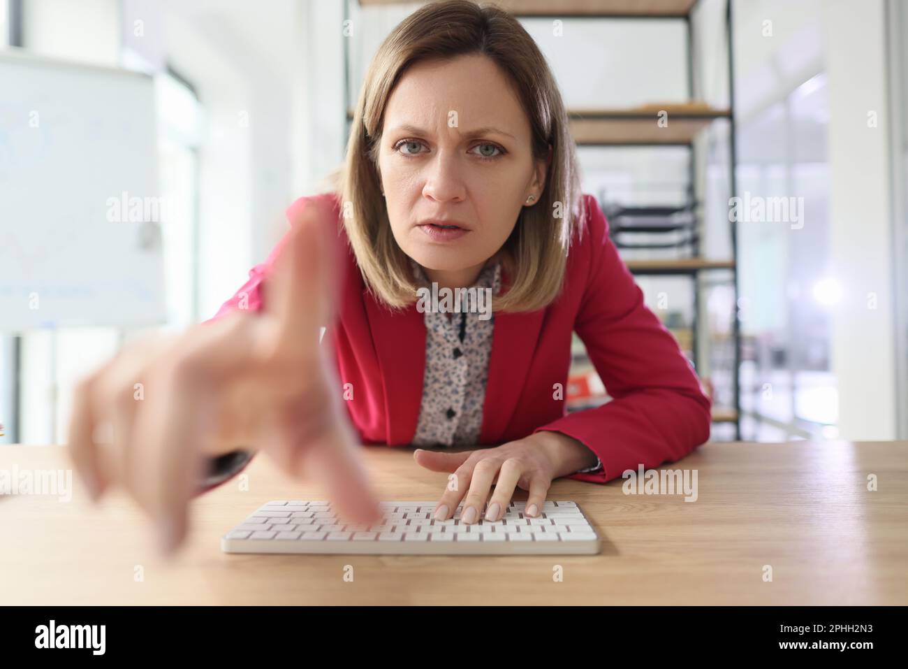Angry woman pokes index finger at monitor typing on keyboard Stock ...