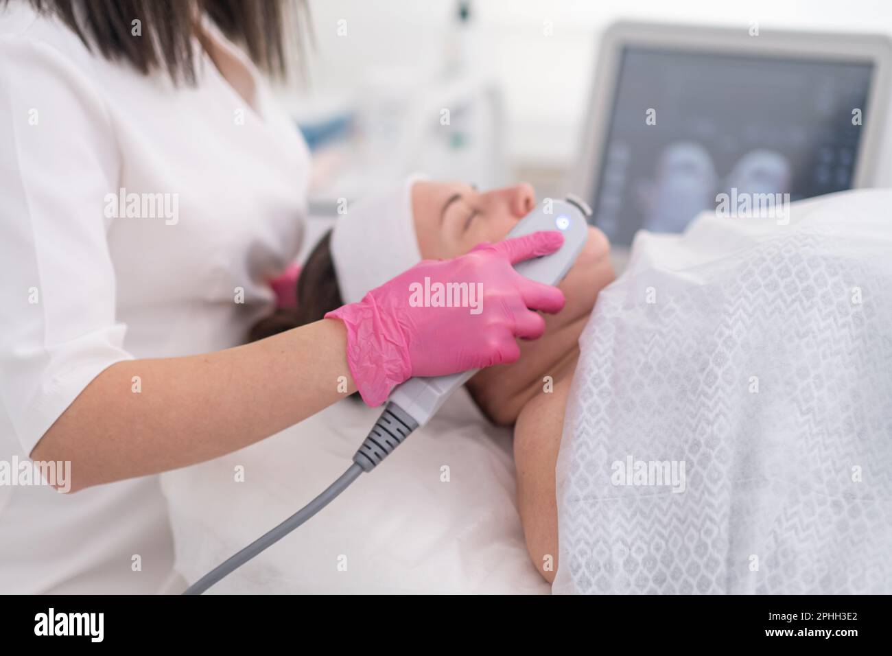 Woman receiving innovative procedure hi-res stock photography and ...