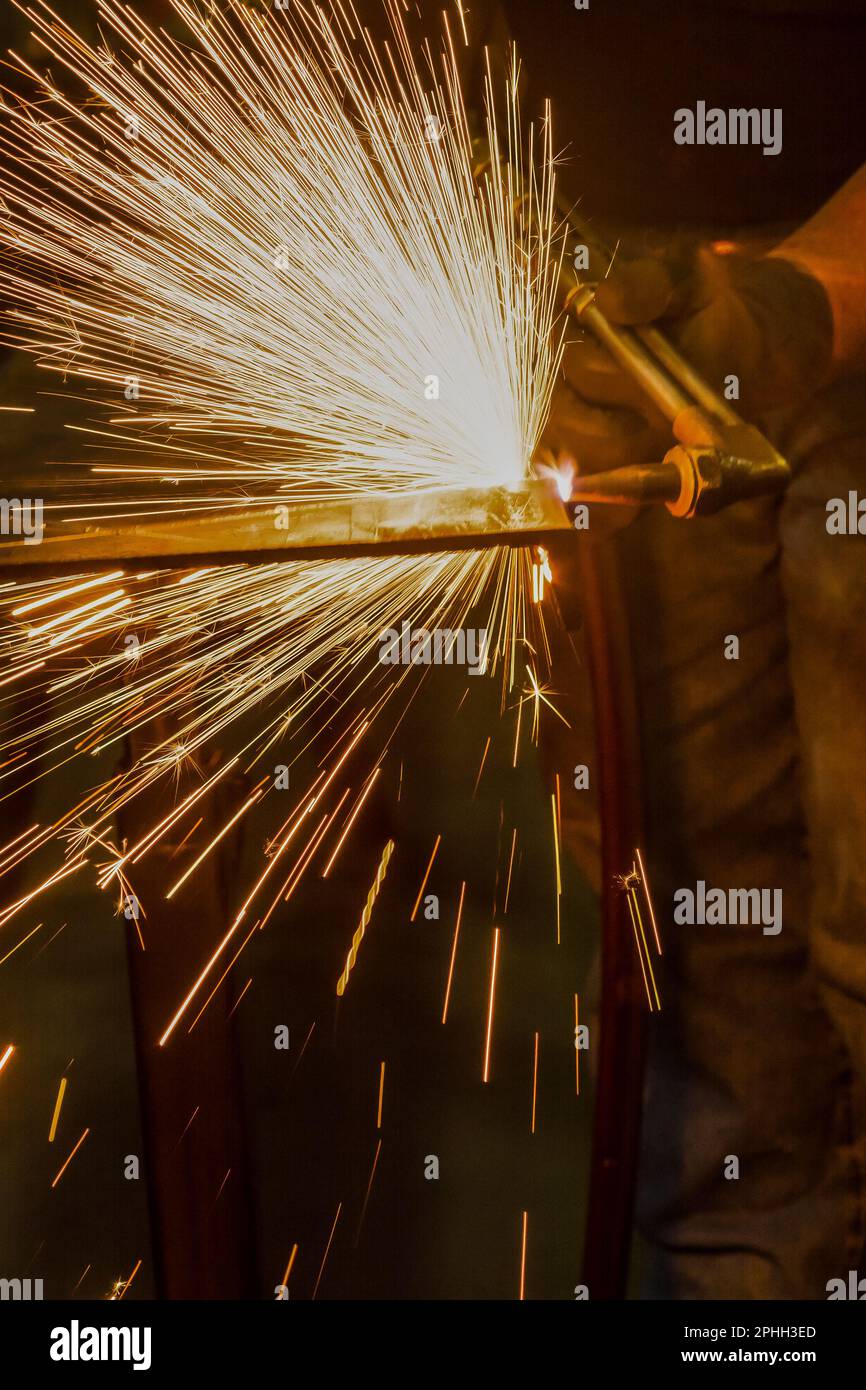 tight photos of man using a gas cutting torch to cut steel Stock Photo ...