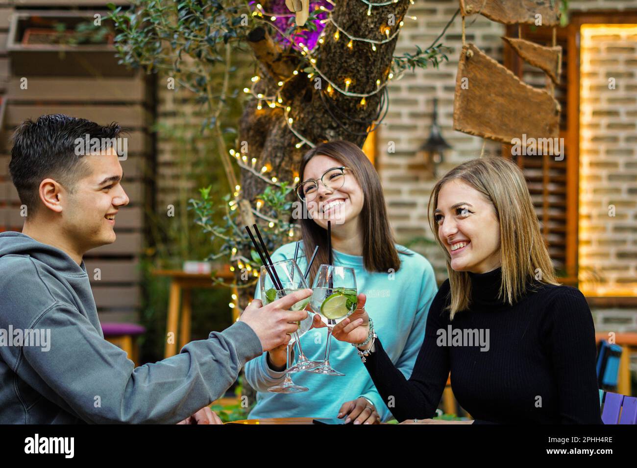 Young people have fun in a bar - Friends drinking cocktails together ...