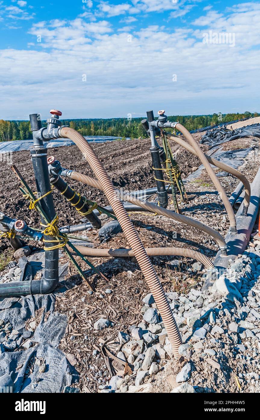 Two methane gas well head pipes in an active landfill Stock Photo - Alamy