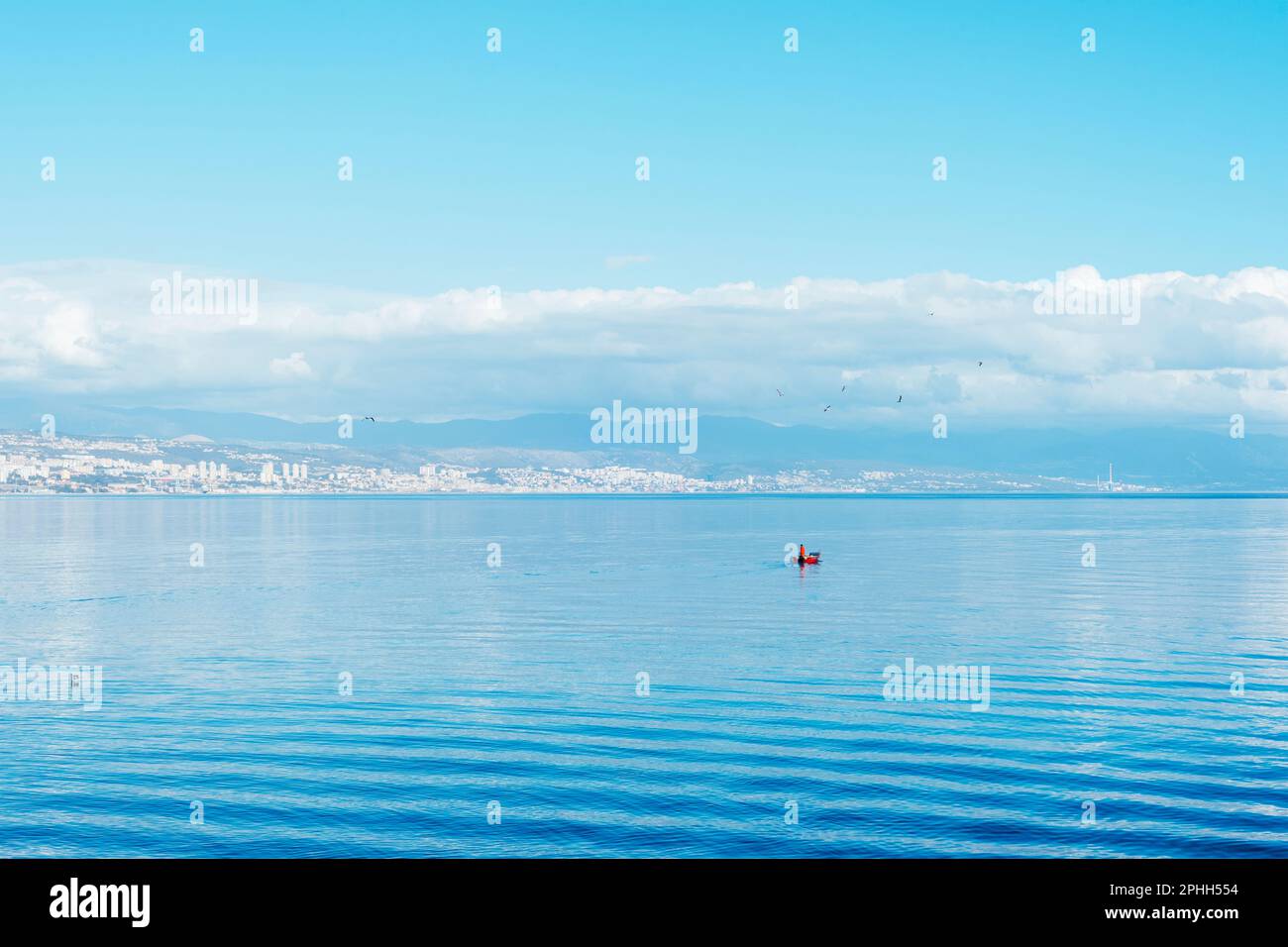 Beautiful blue sea with fishing boat. View of Rijeka city, Croatia ...