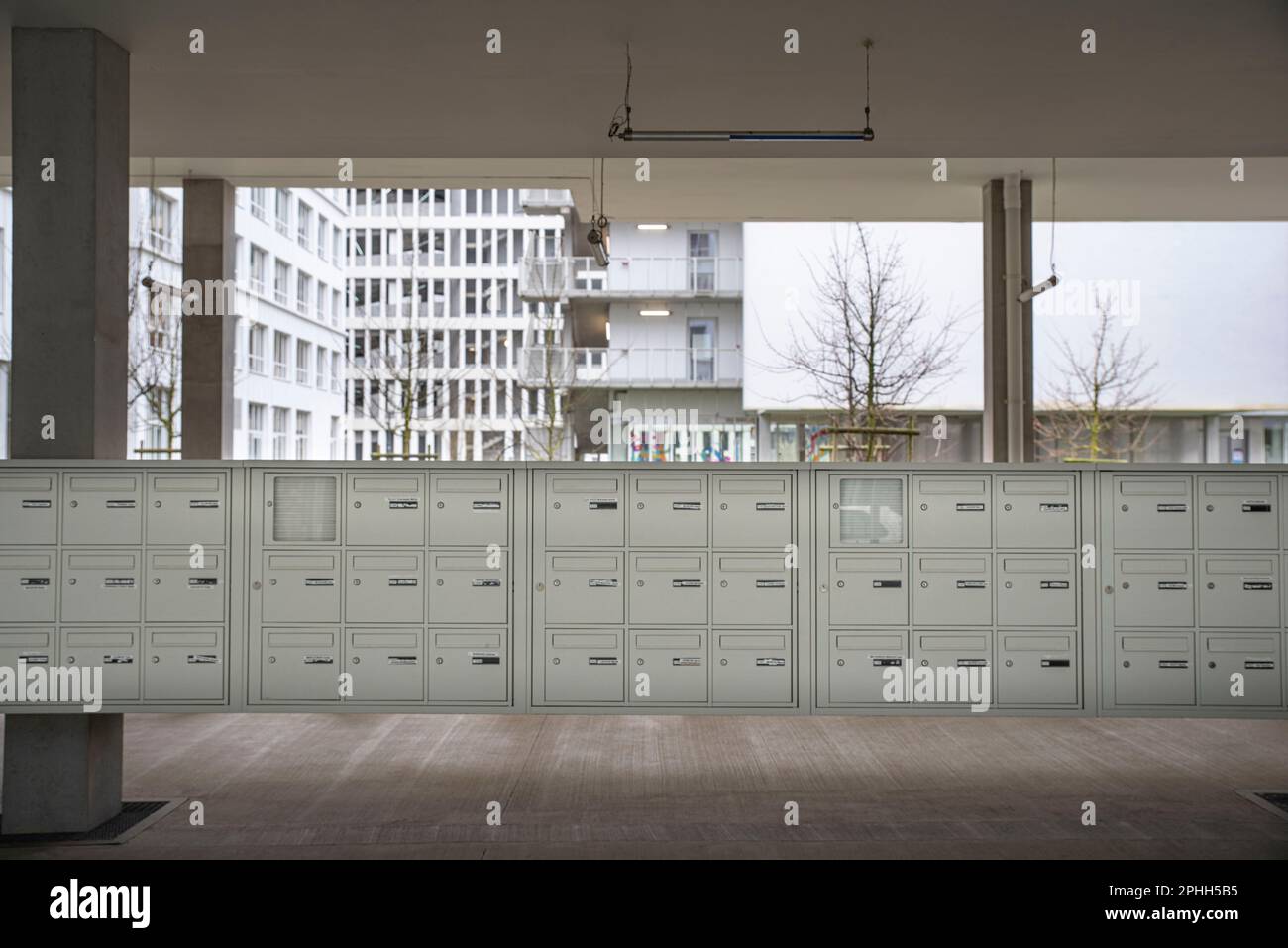 A group of letterboxes at the foot of an apartment building Stock Photo ...