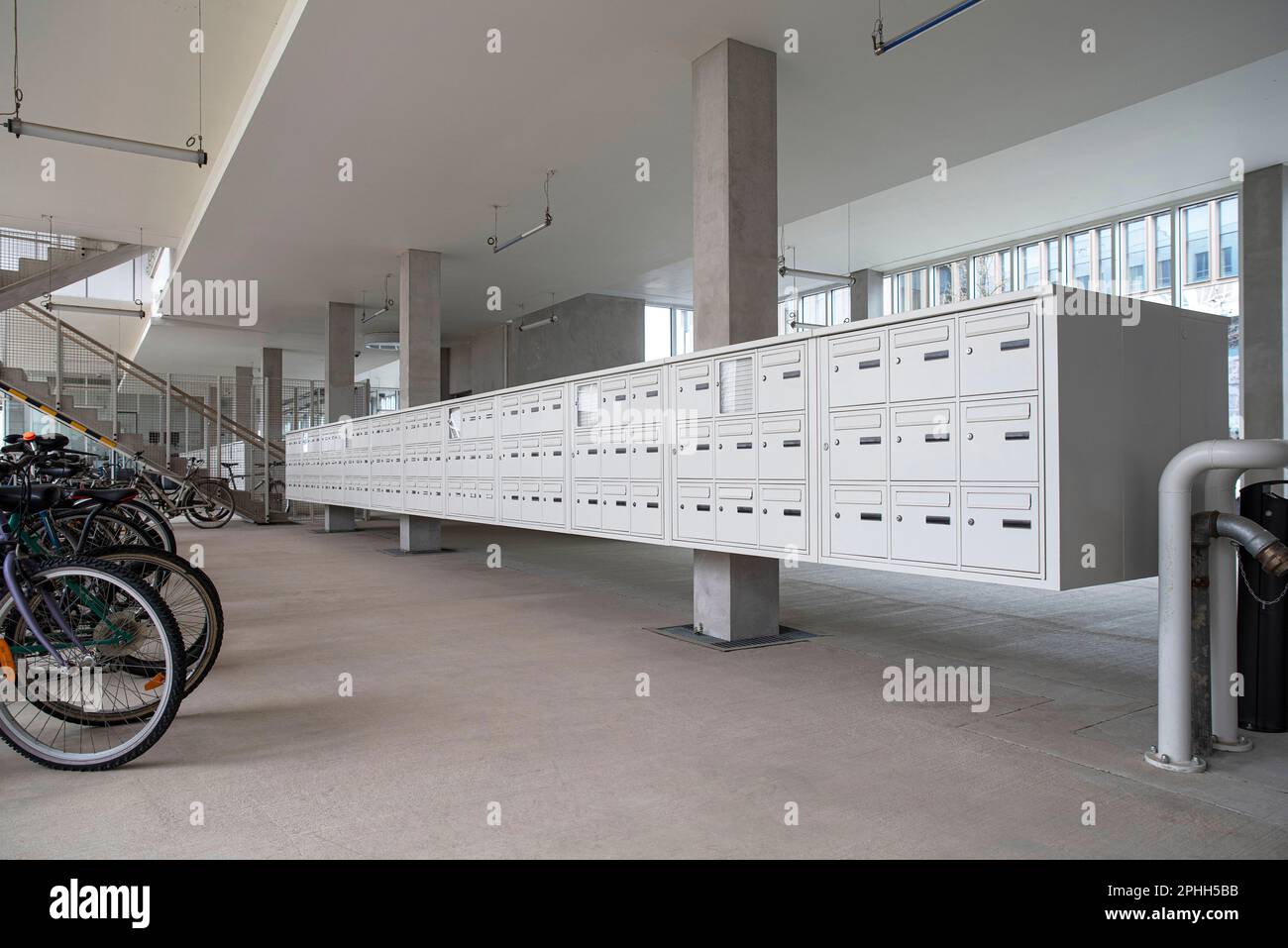 A group of letterboxes at the foot of an apartment building Stock Photo ...