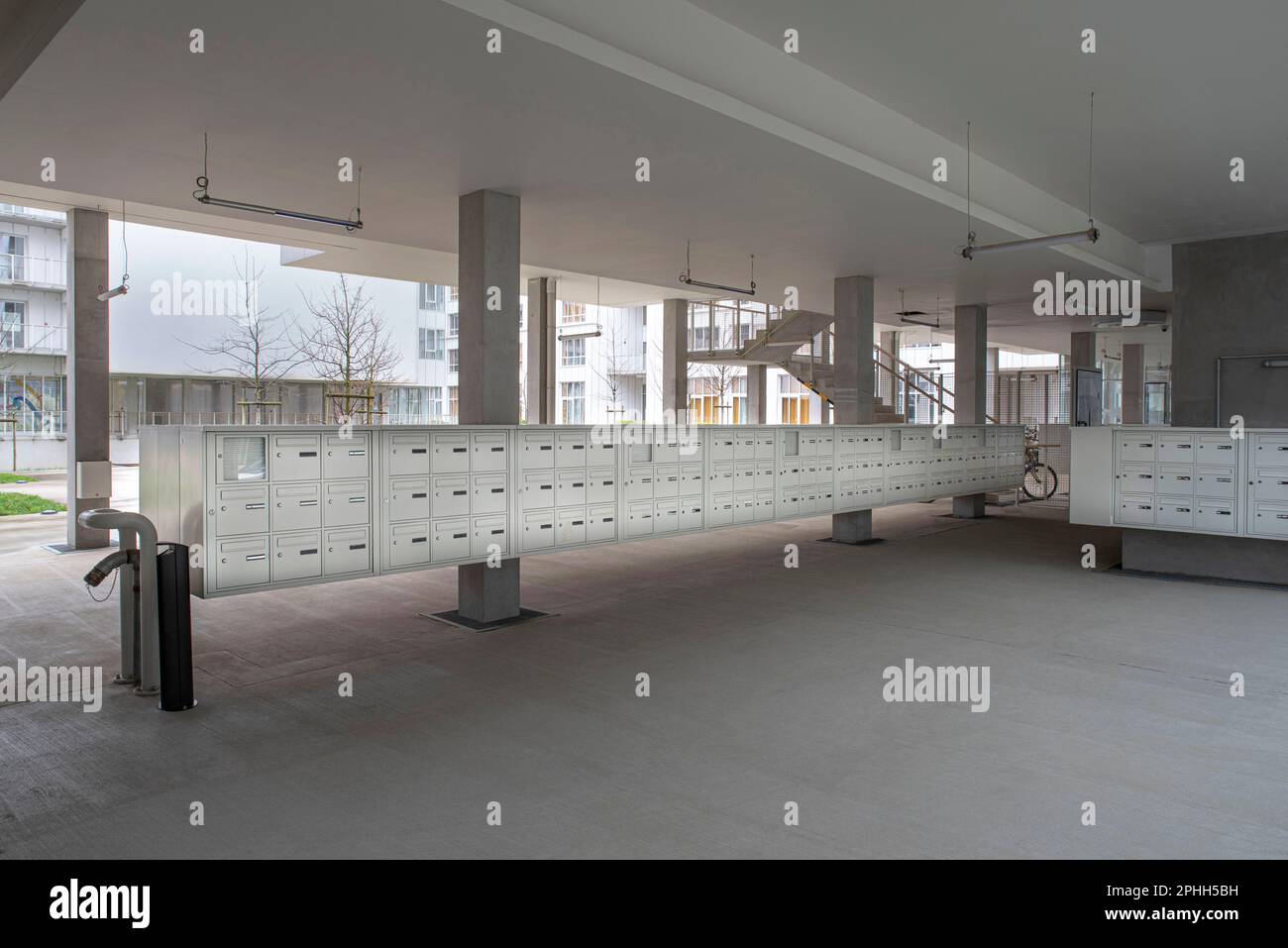 A group of letterboxes at the foot of an apartment building Stock Photo ...