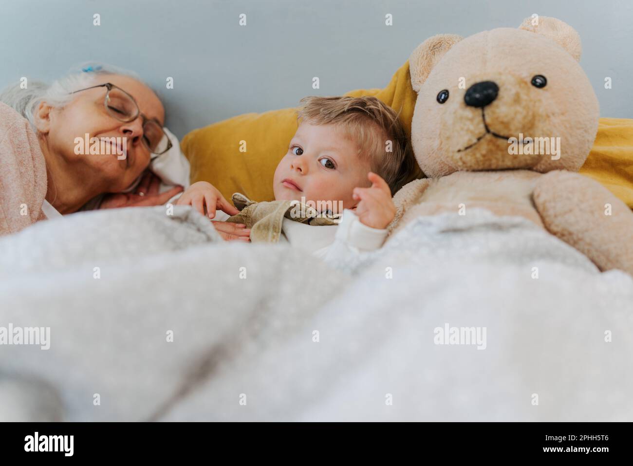 Grandmother lying with her grandson in the bed Stock Photo - Alamy