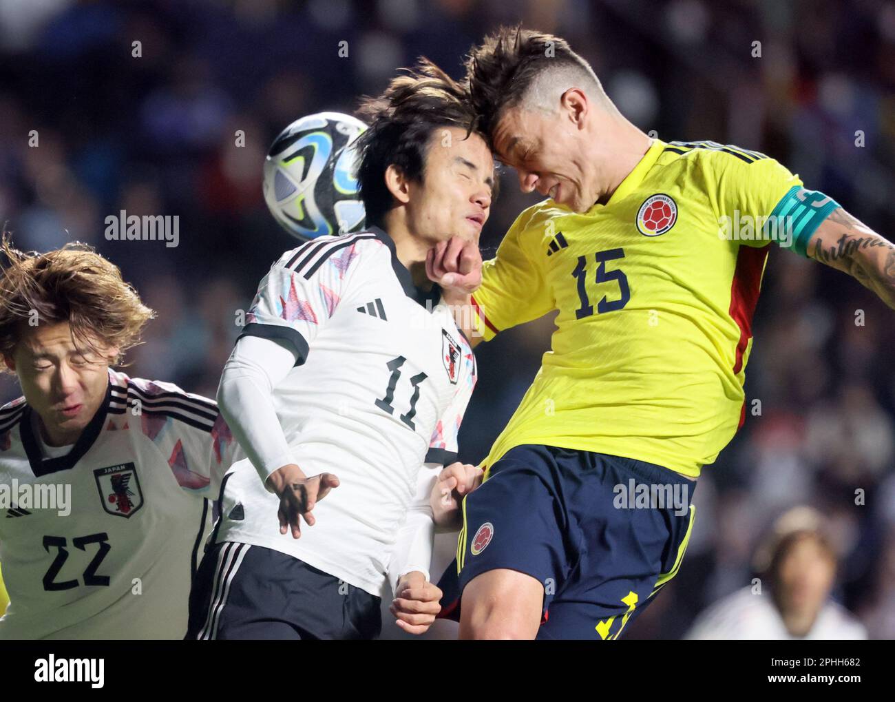 Osaka, Japan. 28th Mar, 2023. Japan's Takefusa Kubo (C) fights the high ...