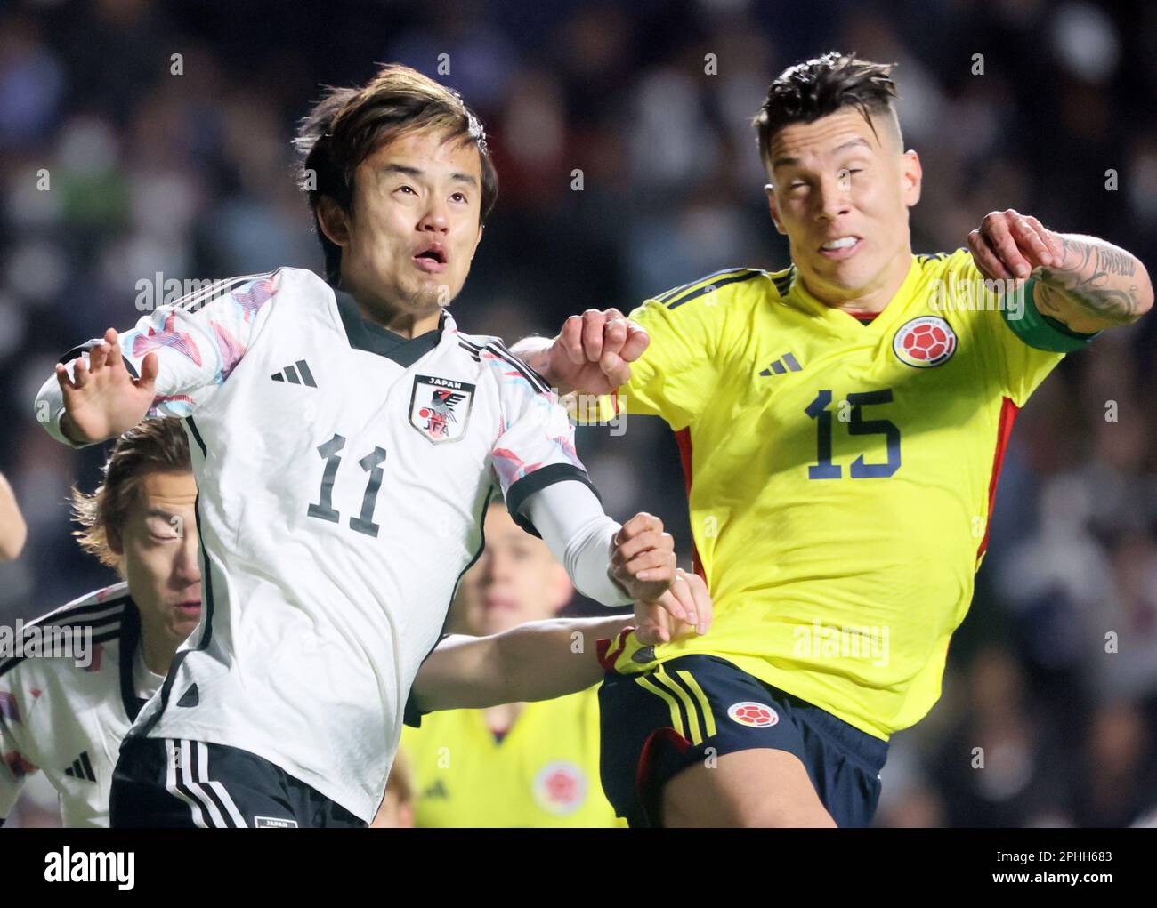 Osaka, Japan. 28th Mar, 2023. Japan's Takefusa Kubo (L) fights the high ...