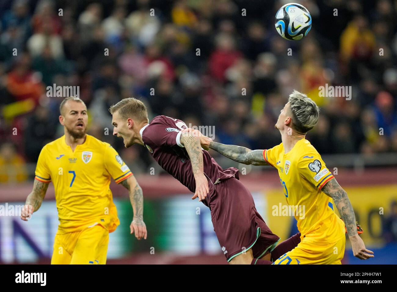 Romania's Dennis Man pushes Belarus' Zakhar Volkov during the Euro 2024 ...