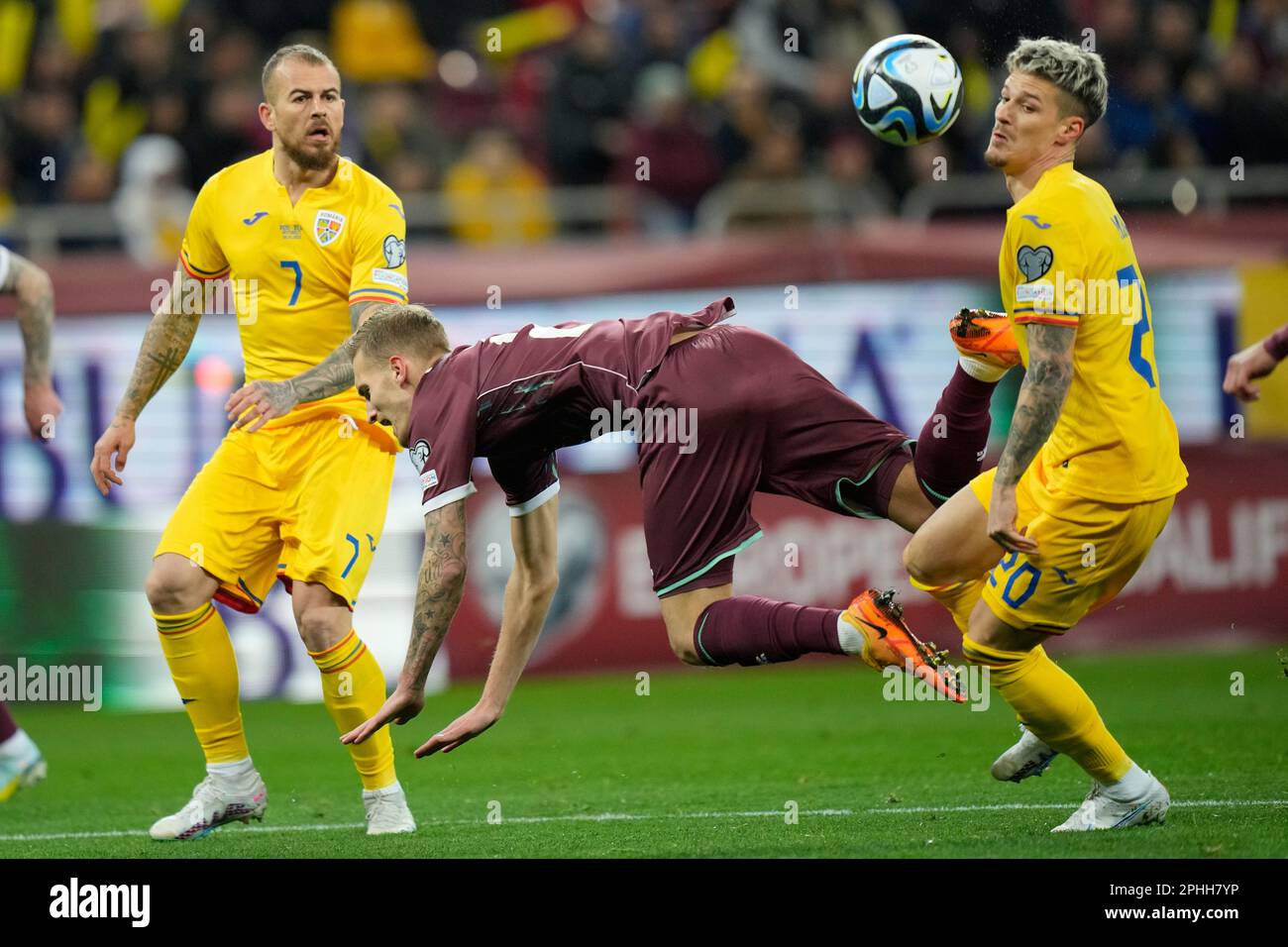 Romania's Dennis Man pushes Belarus' Zakhar Volkov during the Euro 2024 ...