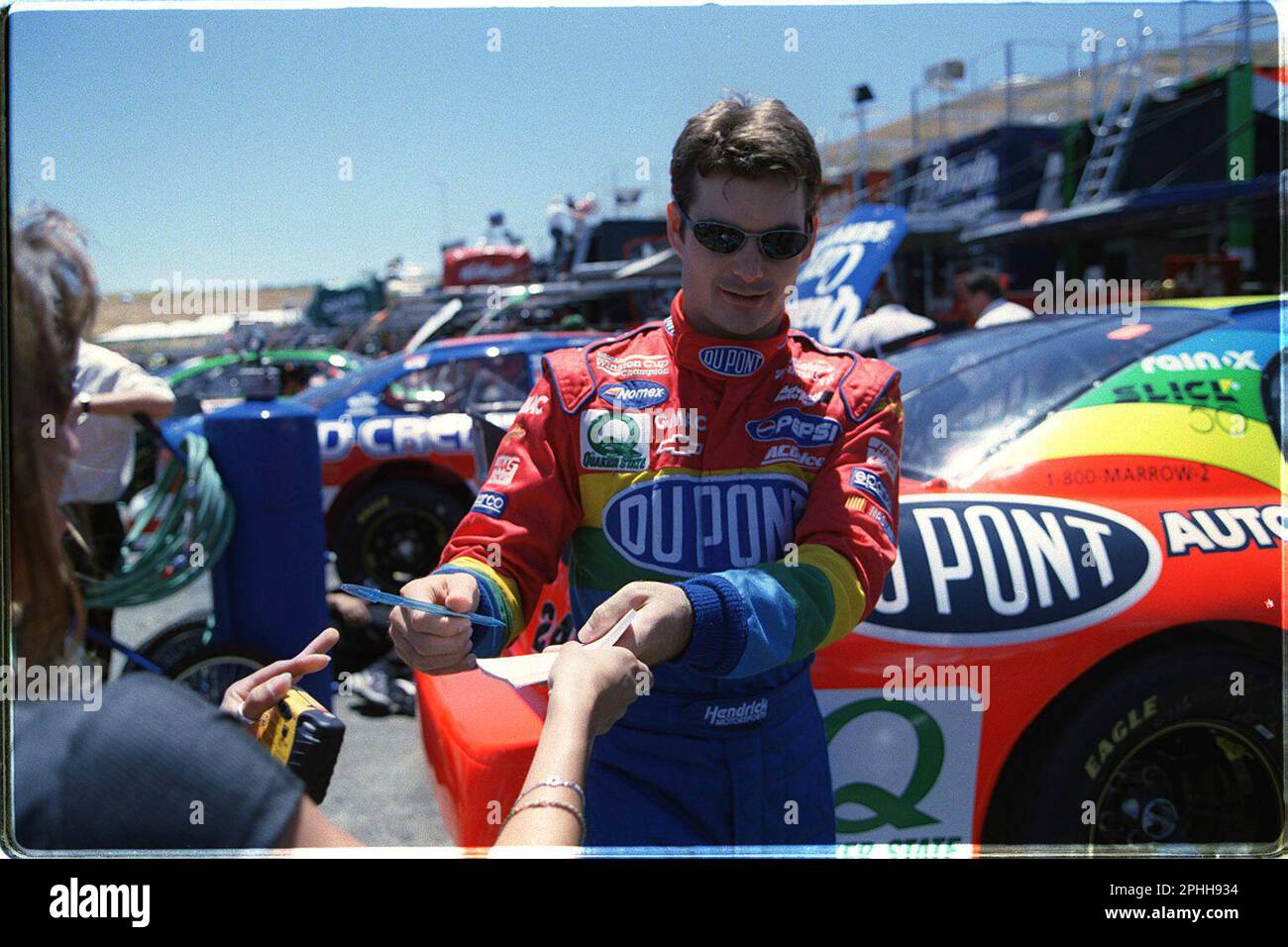 NASCAR 3/C/25JUN99/SP/LS --- From right: Jeff Gordon signs an autograph ...