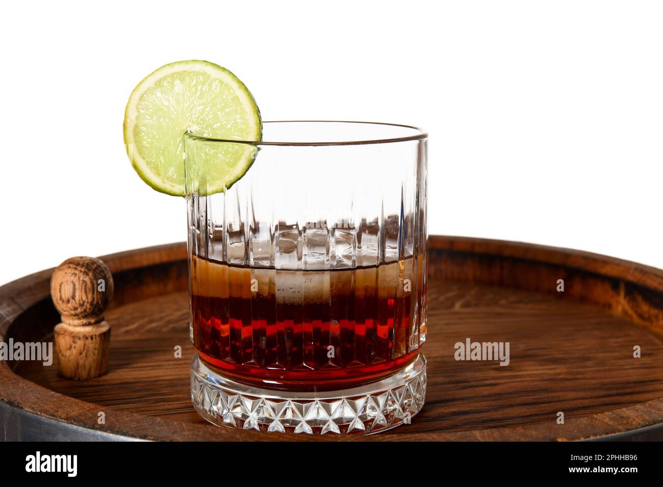 Glass of cold rum on wooden barrel against white background Stock Photo ...