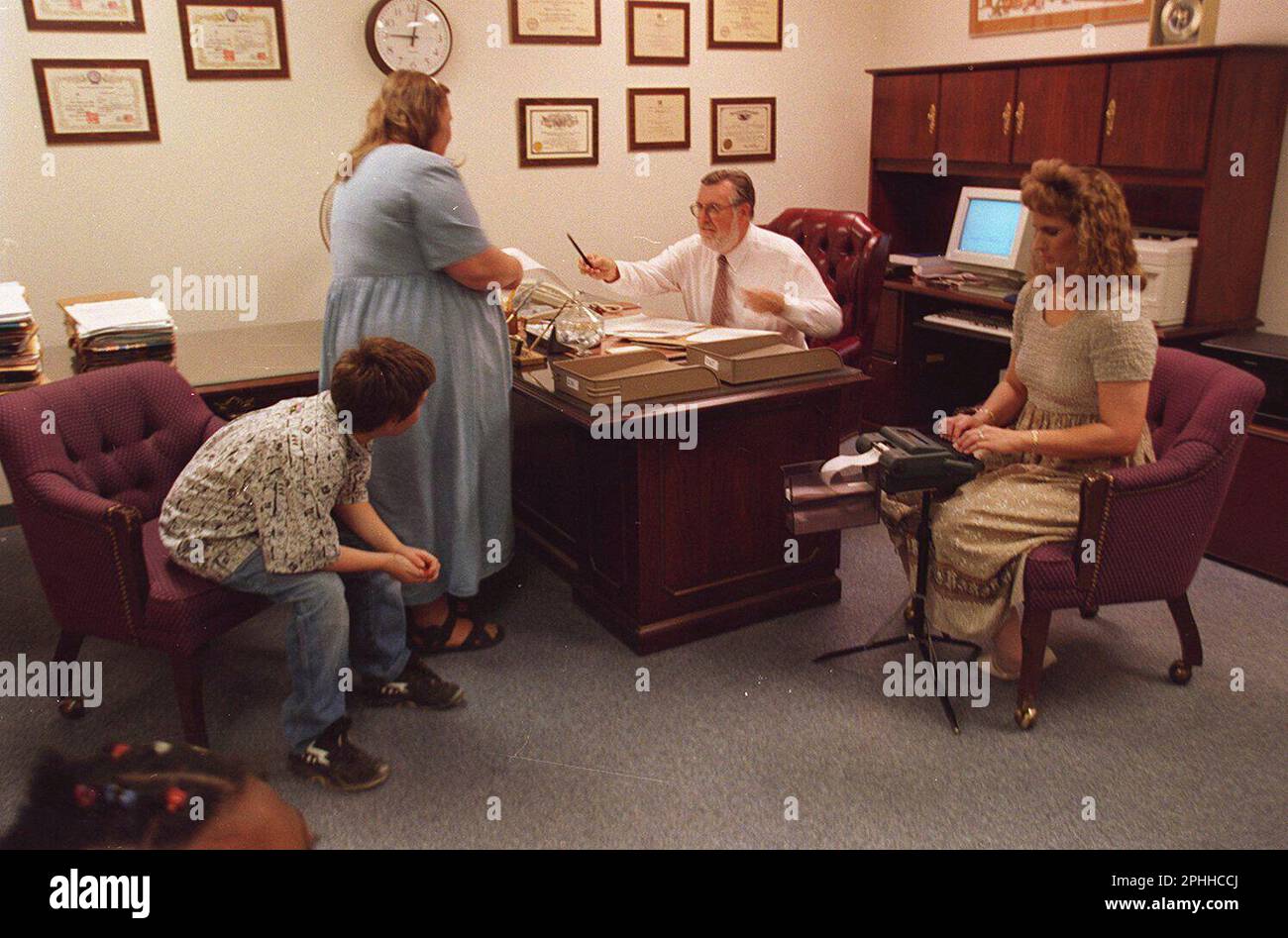 JASON 2/C/19MAY97/CD/LS ----- Jason peers around his mother as Judge ...