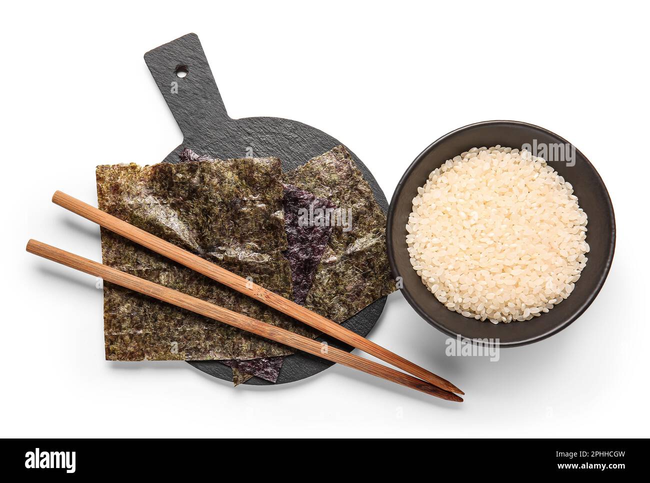 Board with natural nori sheets, chopsticks and bowl of rice isolated on ...