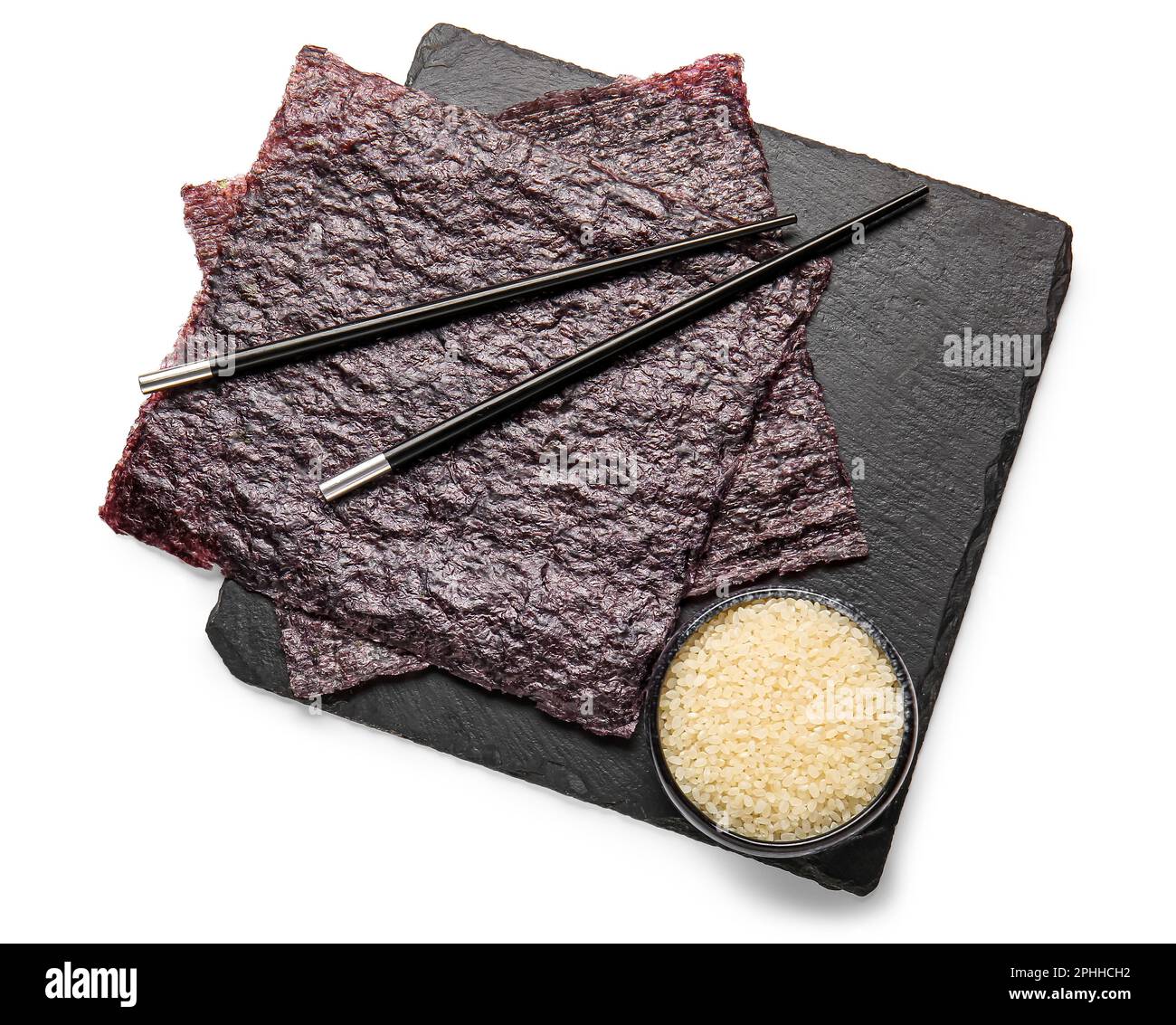Slate board with natural nori sheets, chopsticks and bowl of rice ...