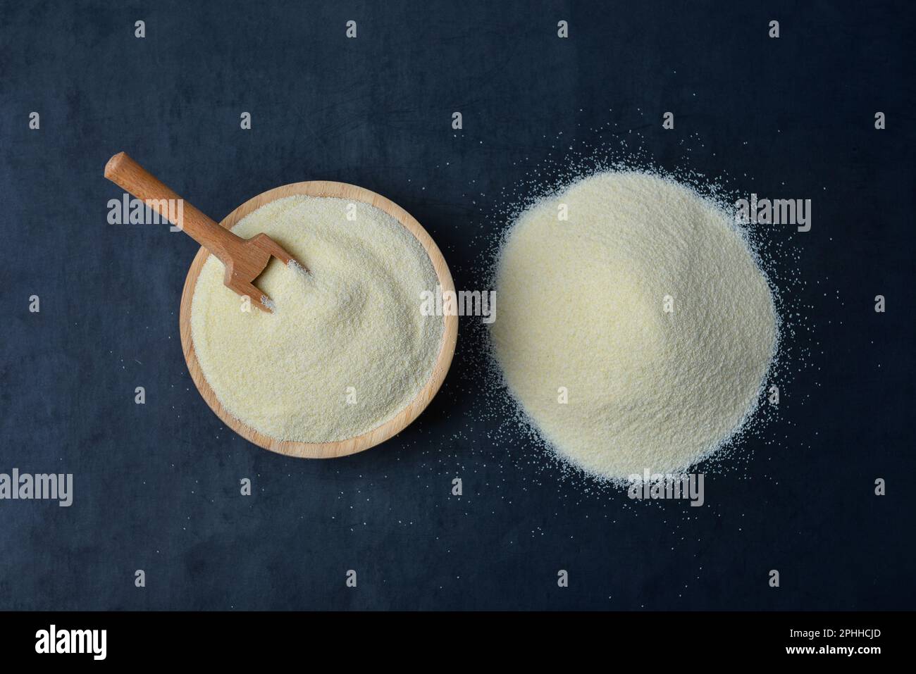 Bowl and heap of raw semolina on blue background Stock Photo - Alamy