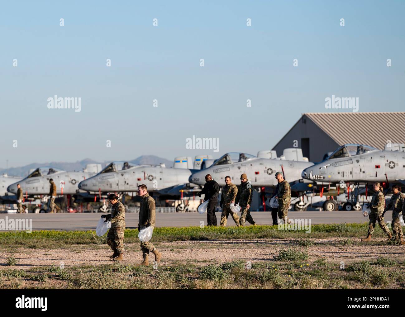 Desert Lightning Team members walk along the flight line in search of ...