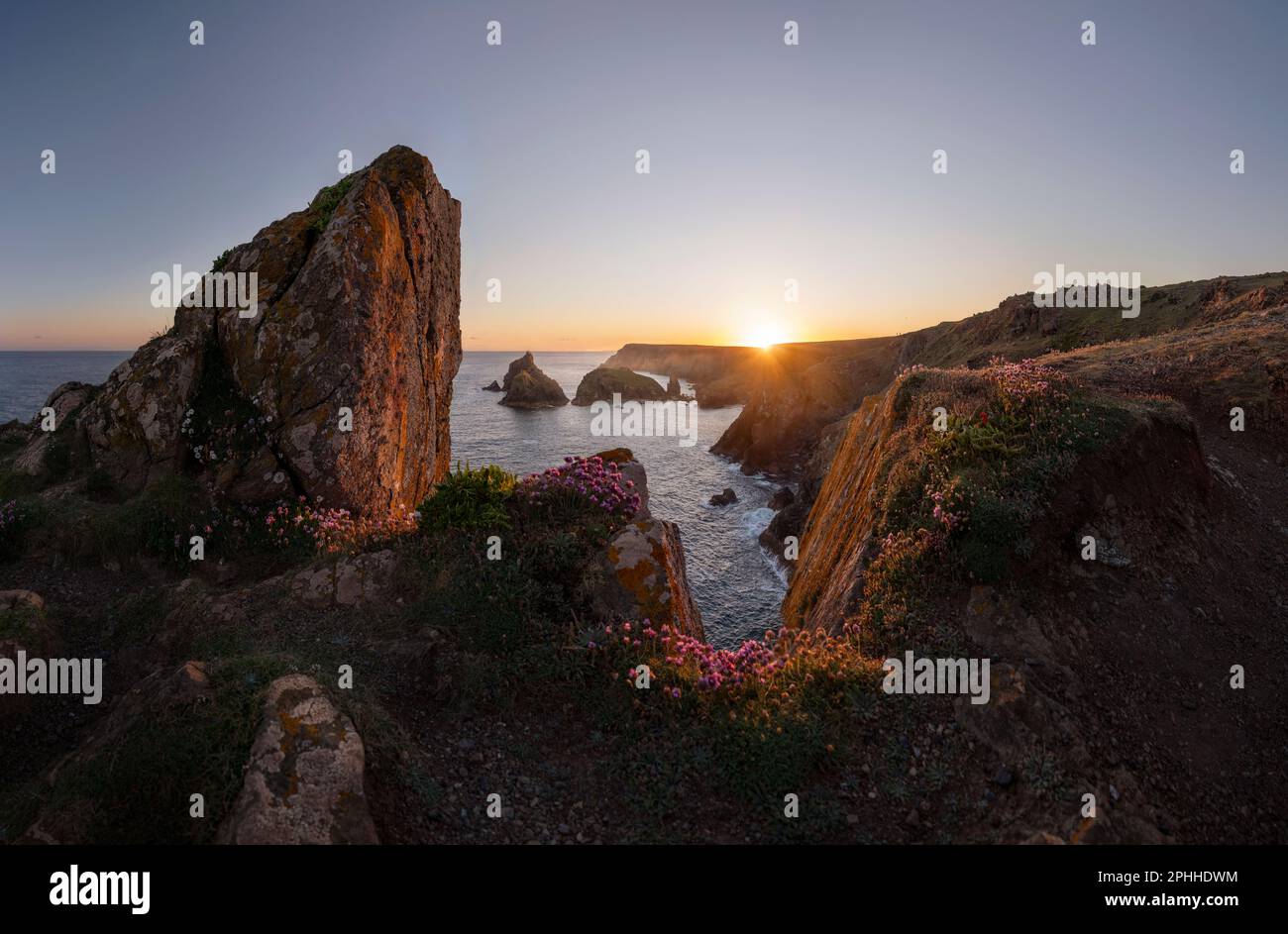 Sunset, a cliff edge on the Lizard Peninsular, looking down on the rock ...