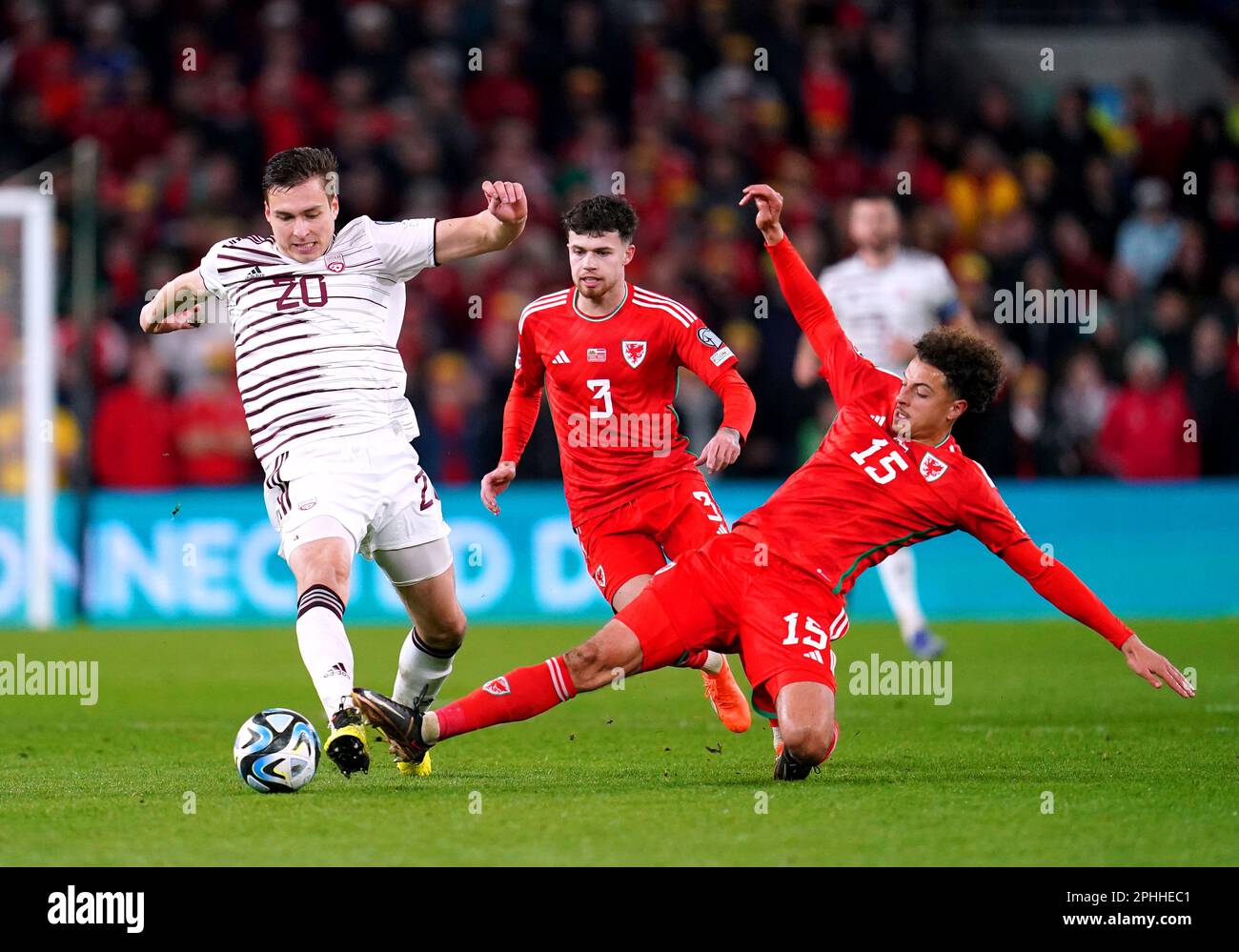 Wales' Ethan Ampadu (right) attempts to tackle Latvia's Roberts ...