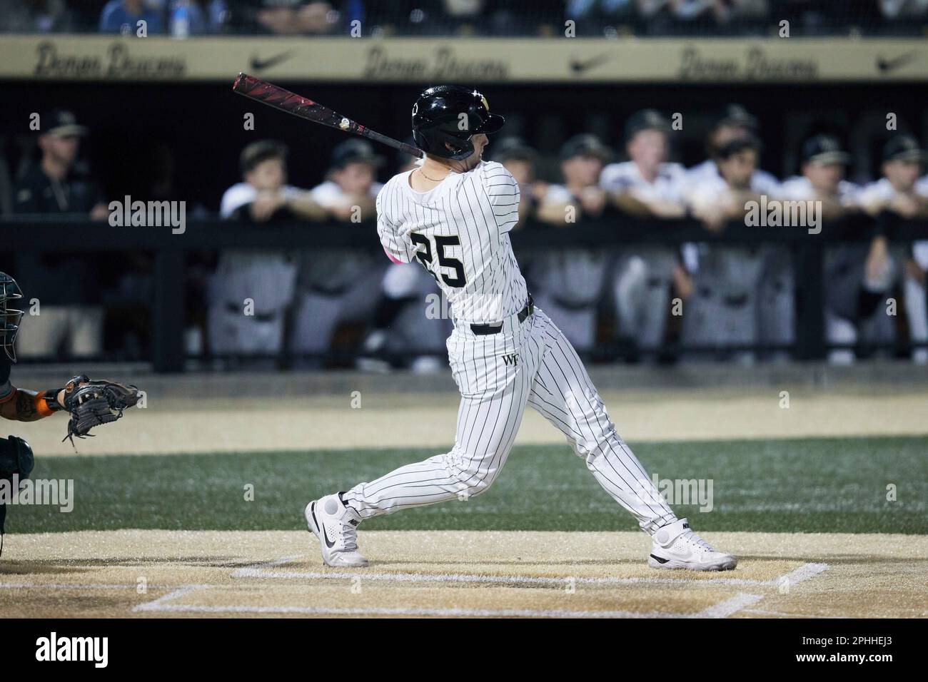 Brock Wilken (25) of the Wake Forest Demon Deacons follows through on ...
