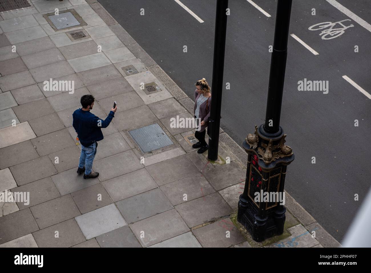 Man takes a photo of a woman, London Stock Photo - Alamy