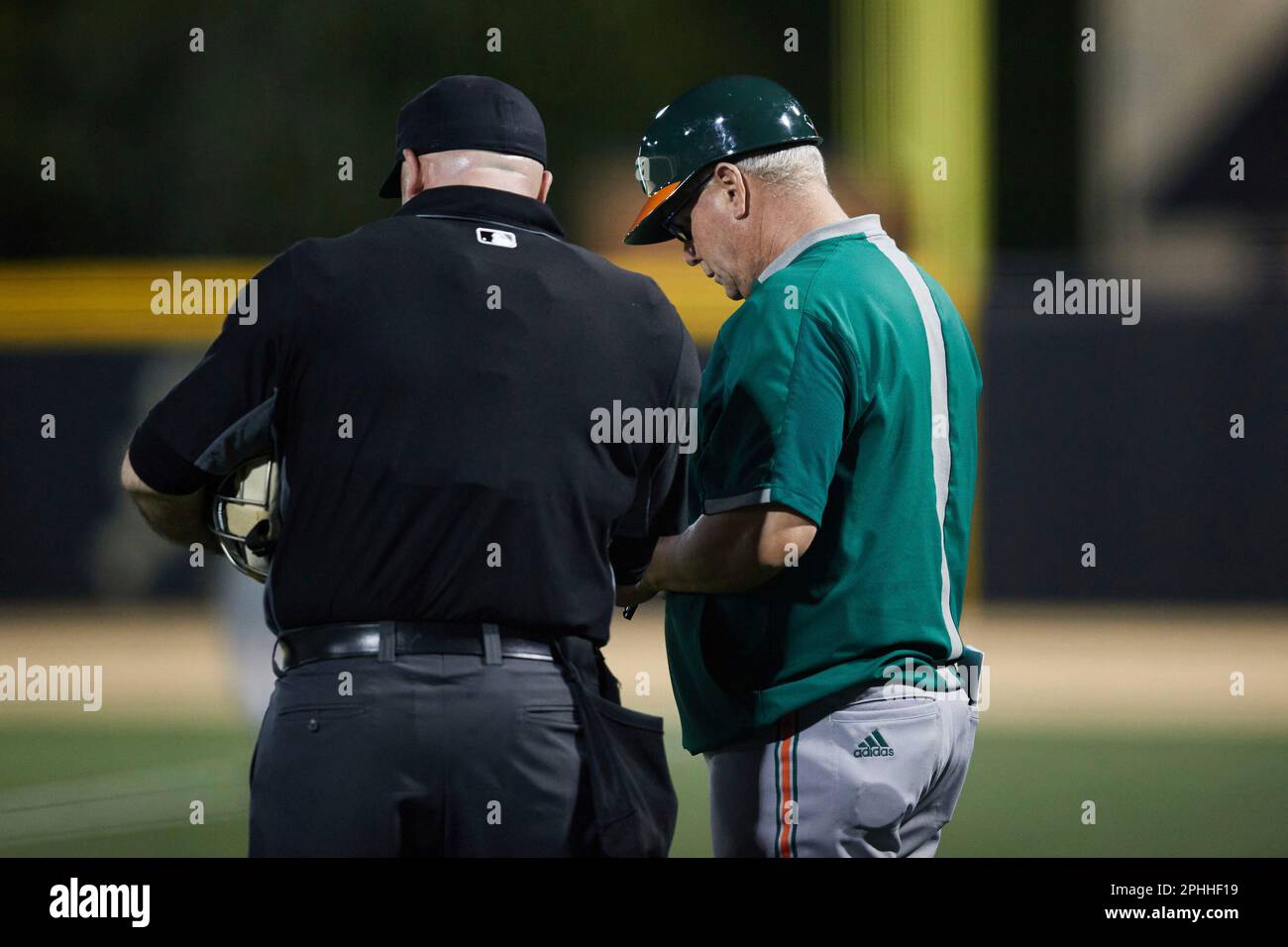 Miami Hurricanes head coach Gino DiMare goes over lineup changes with ...