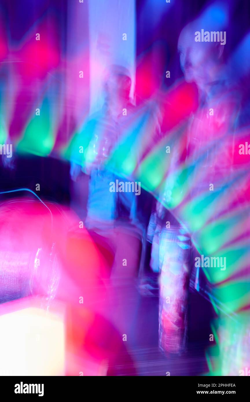 Blurred and slow shutter speed of figures in bright saturated light at ...