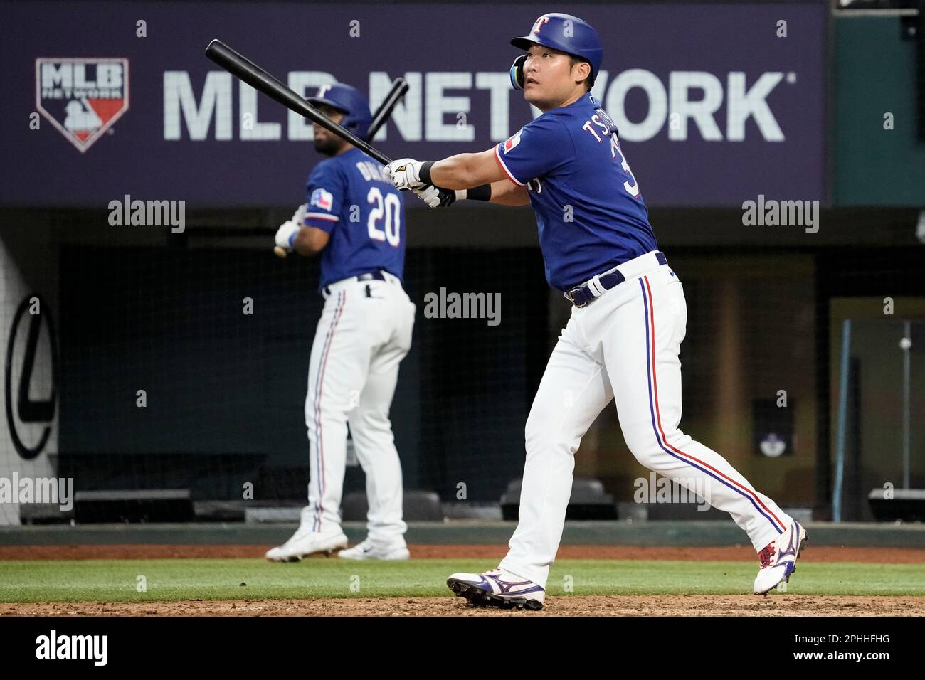 Texas Rangers' Yoshi Tsutsugo watches the flight of a ball that went ...